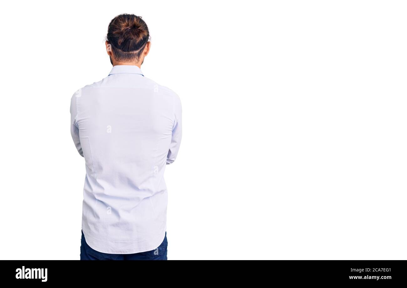 Young handsome man wearing business clothes standing backwards looking ...