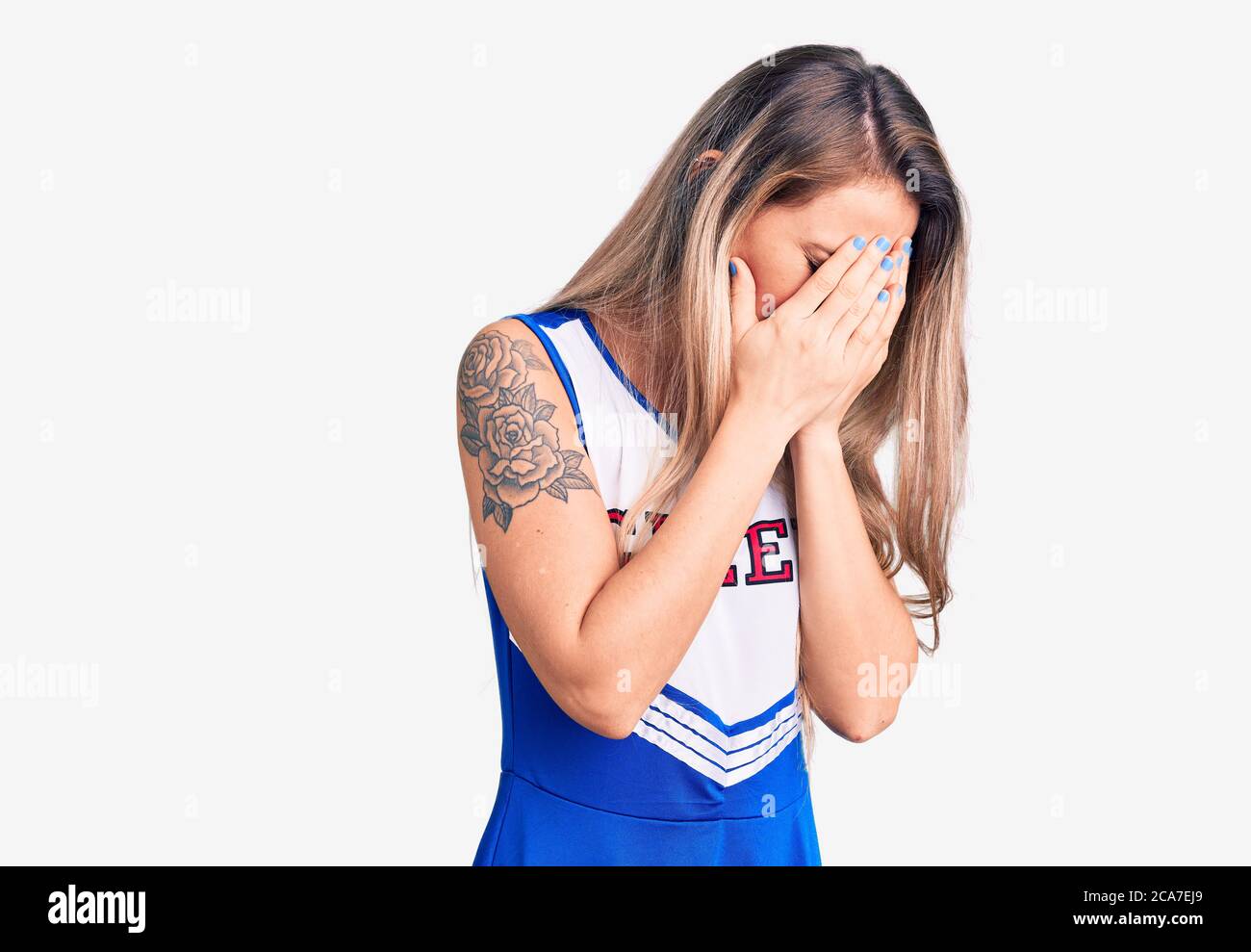 Young beautiful blonde woman wearing cheerleader uniform with sad ...