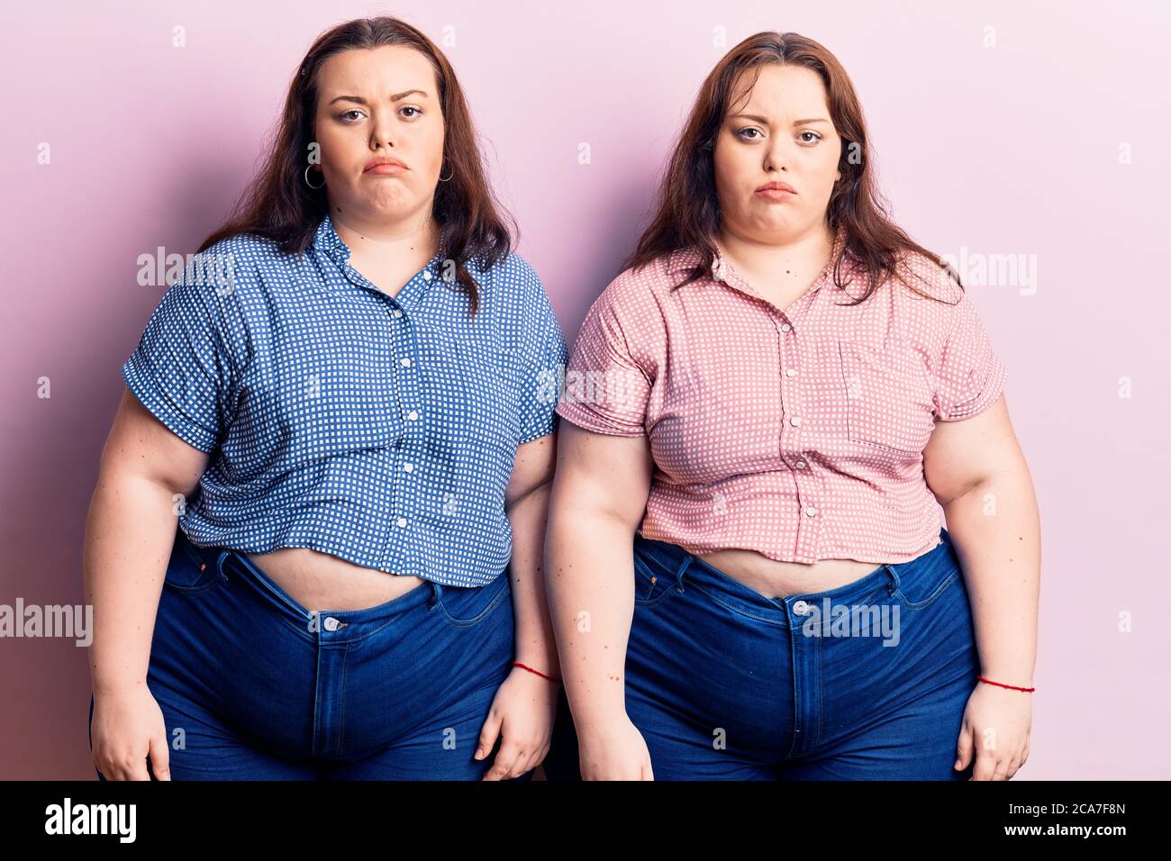 Young plus size twins wearing casual clothes depressed and worry for ...
