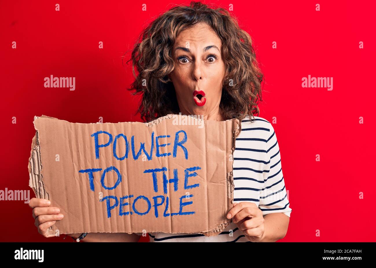 Senior woman asking for social movement holding banner with power to ...