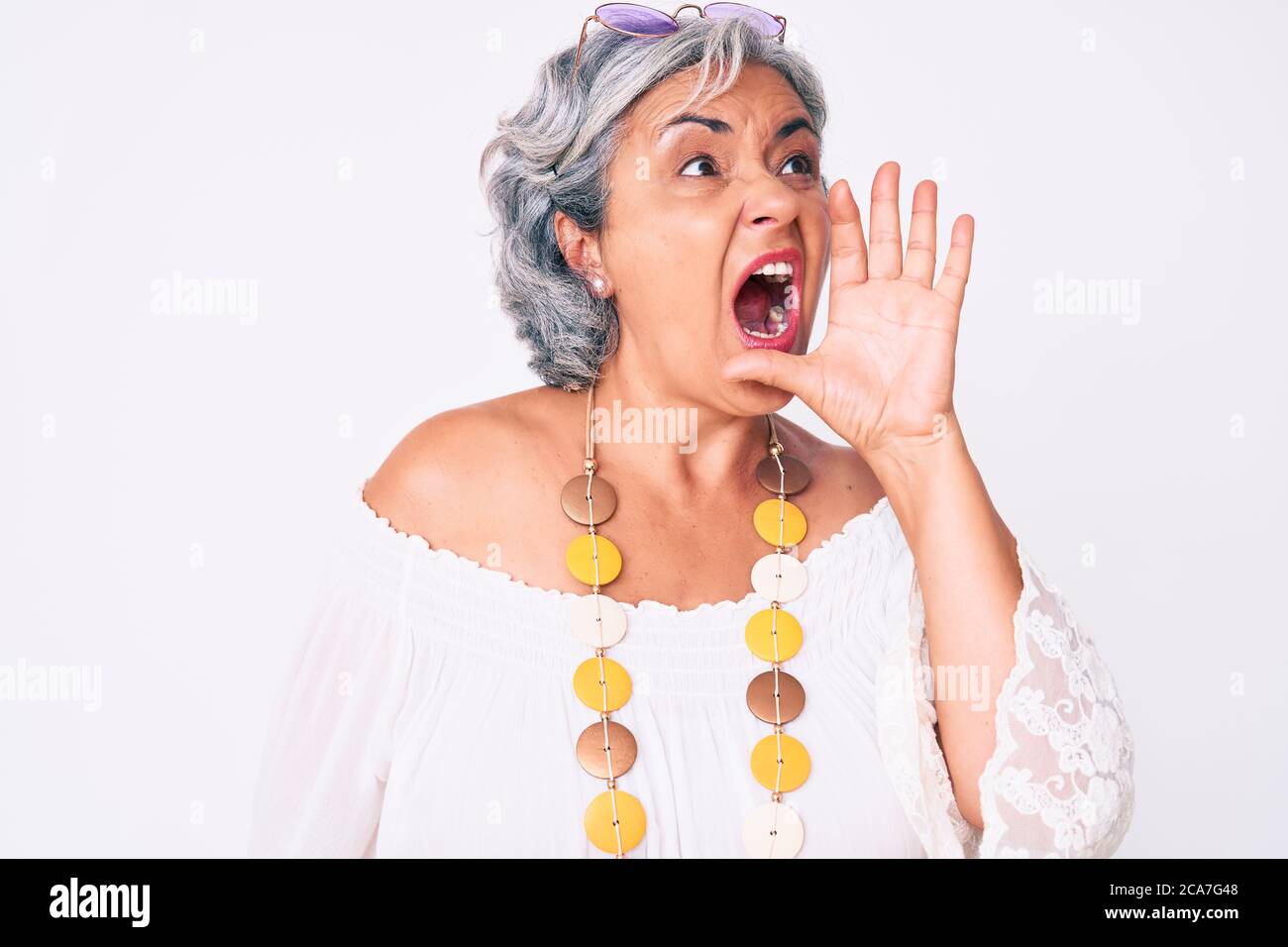 Senior hispanic grey- haired woman wearing casual hippie clothes ...