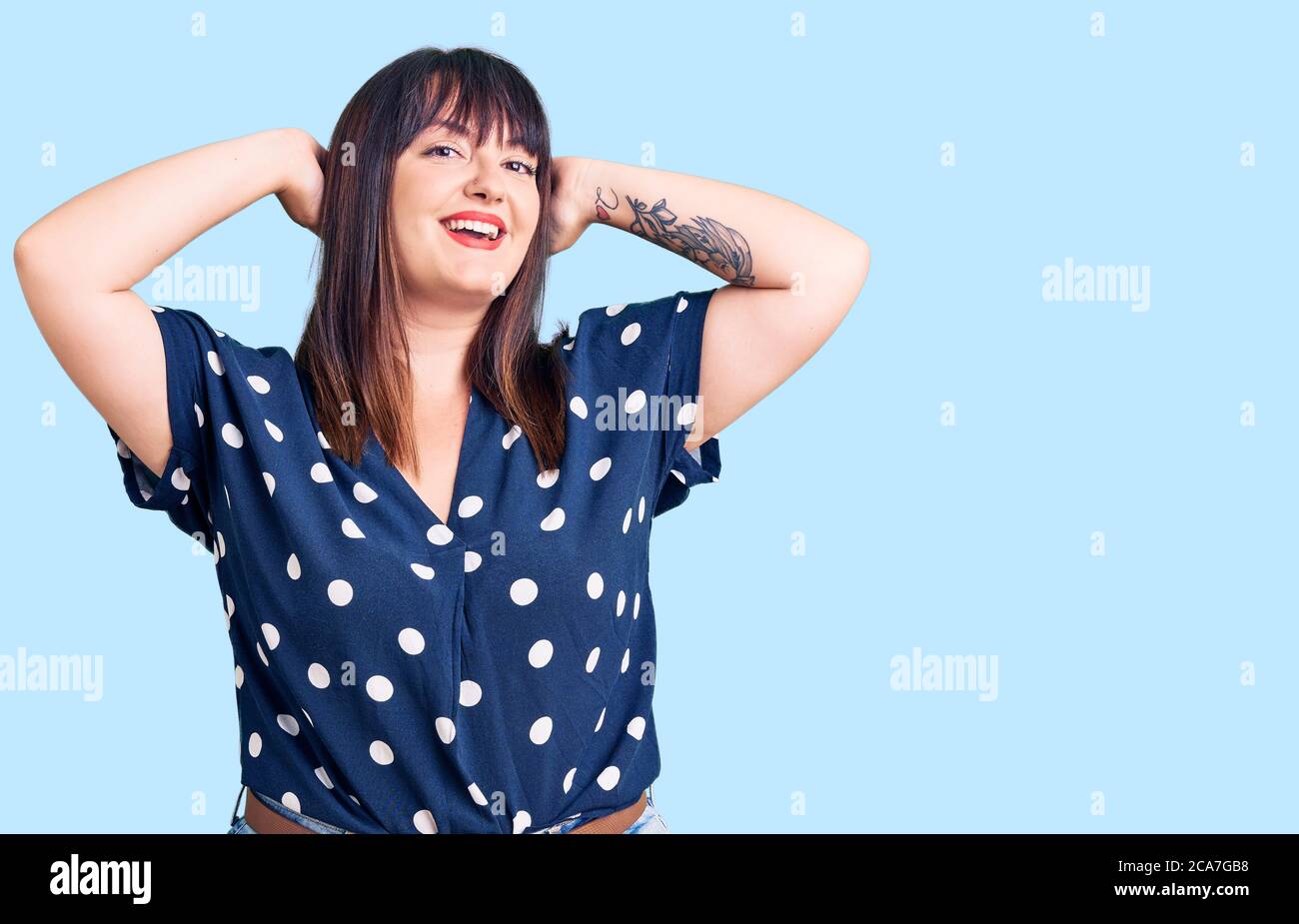 Young plus size woman wearing casual clothes relaxing and stretching ...