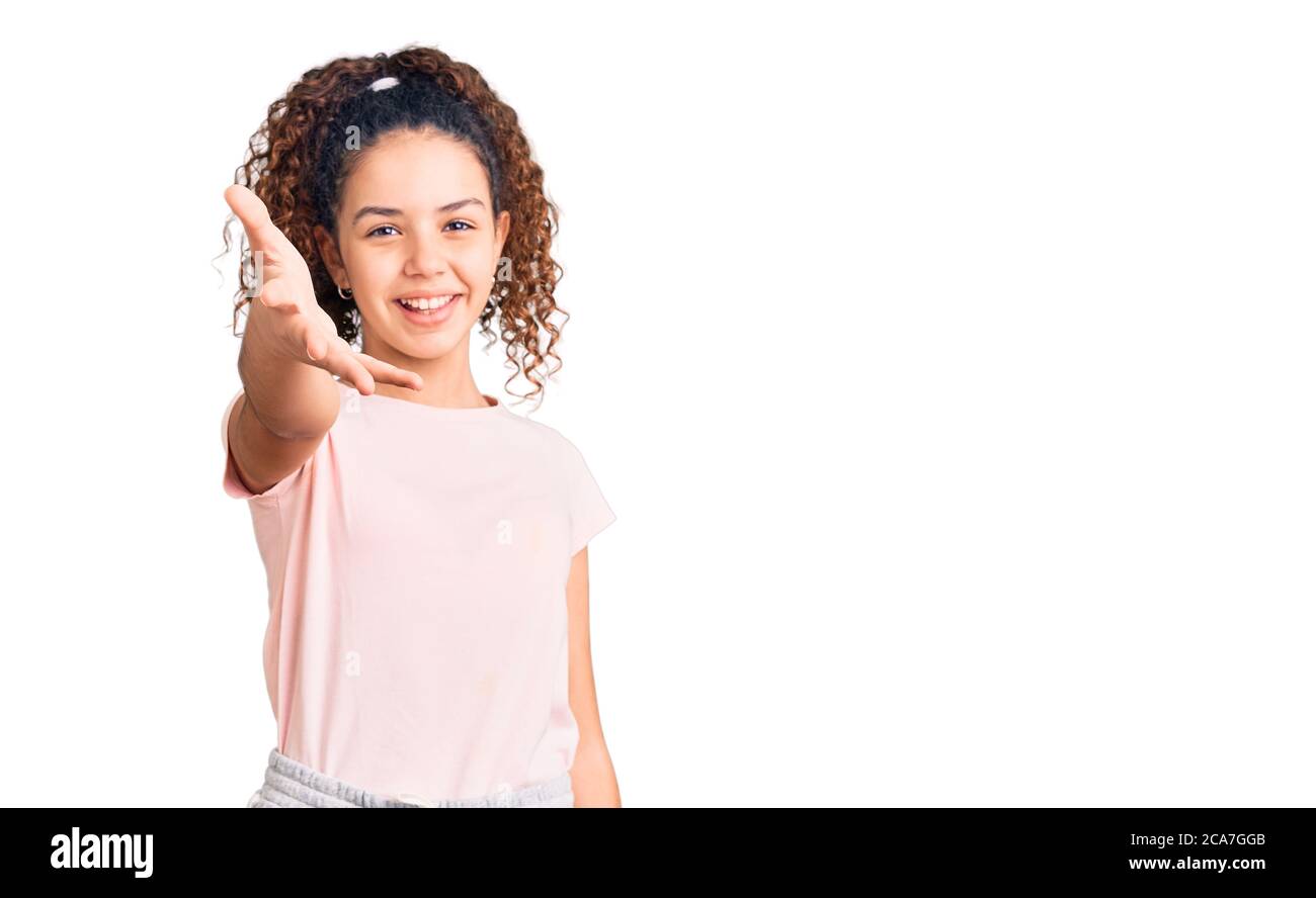 Beautiful kid girl with curly hair wearing casual clothes smiling ...