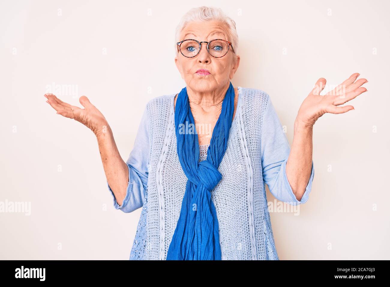 Senior beautiful woman with blue eyes and grey hair wearing casual ...