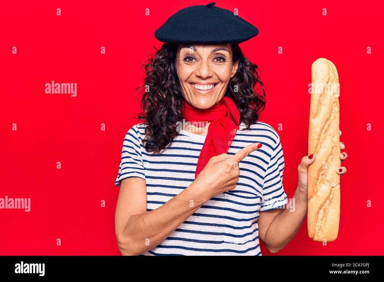 Middle age beautiful woman wearing french beret holding baguette ...