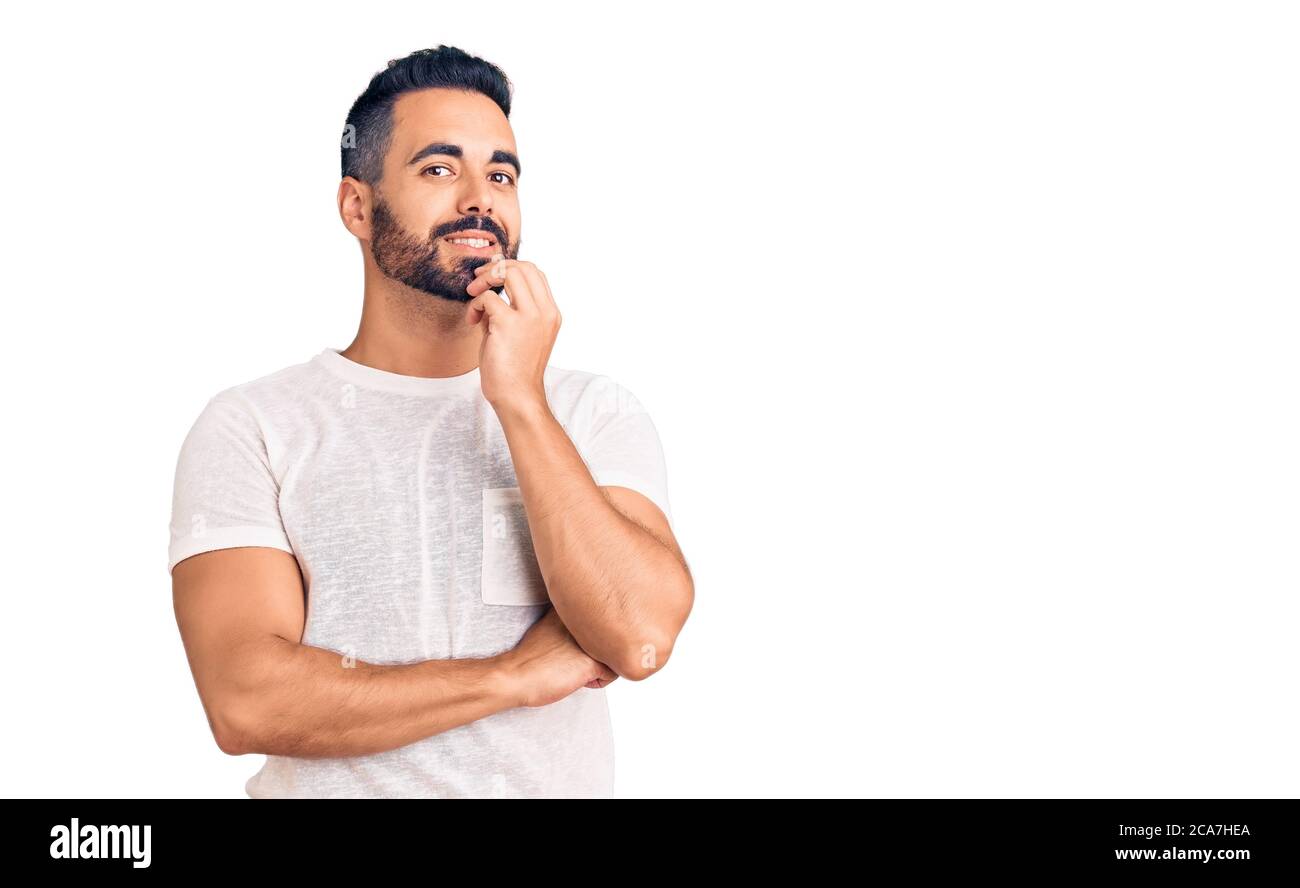 Young hispanic man wearing casual clothes looking confident at the ...