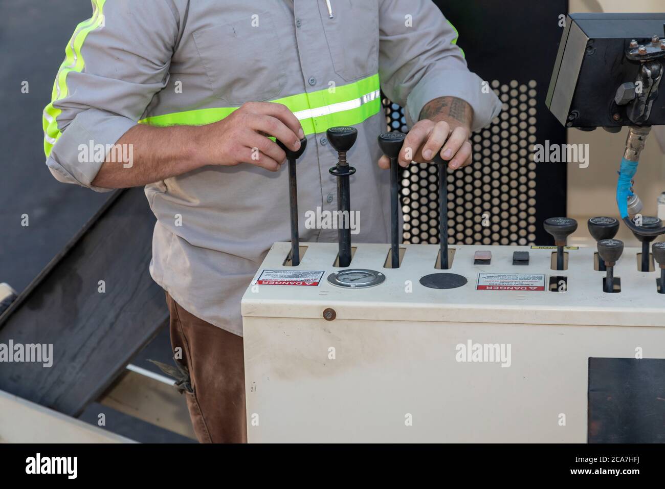 Denver, Colorado - A crane operator handles the controls, lifting a ...