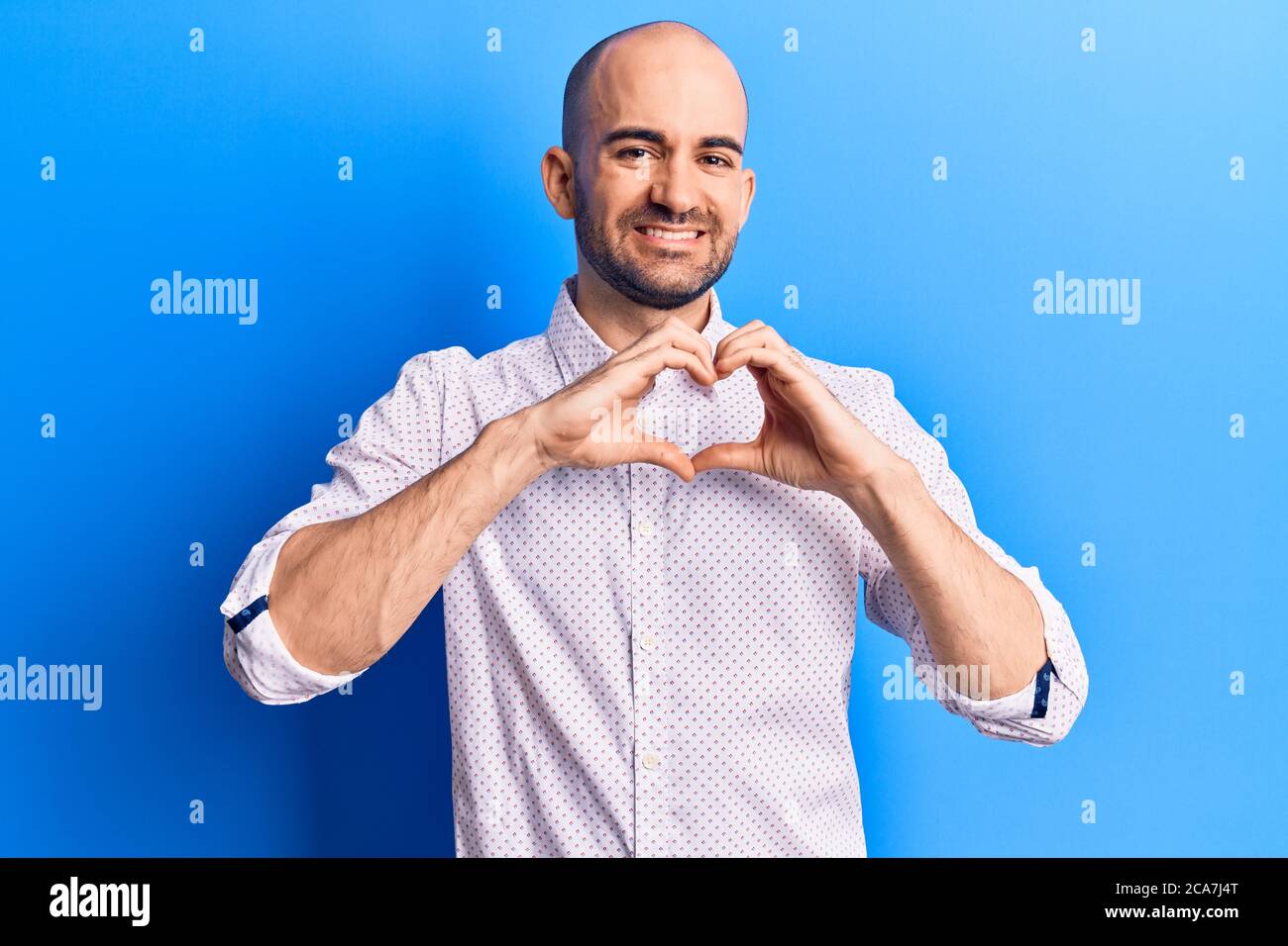 Young handsome bald man wearing elegant shirt smiling in love doing ...
