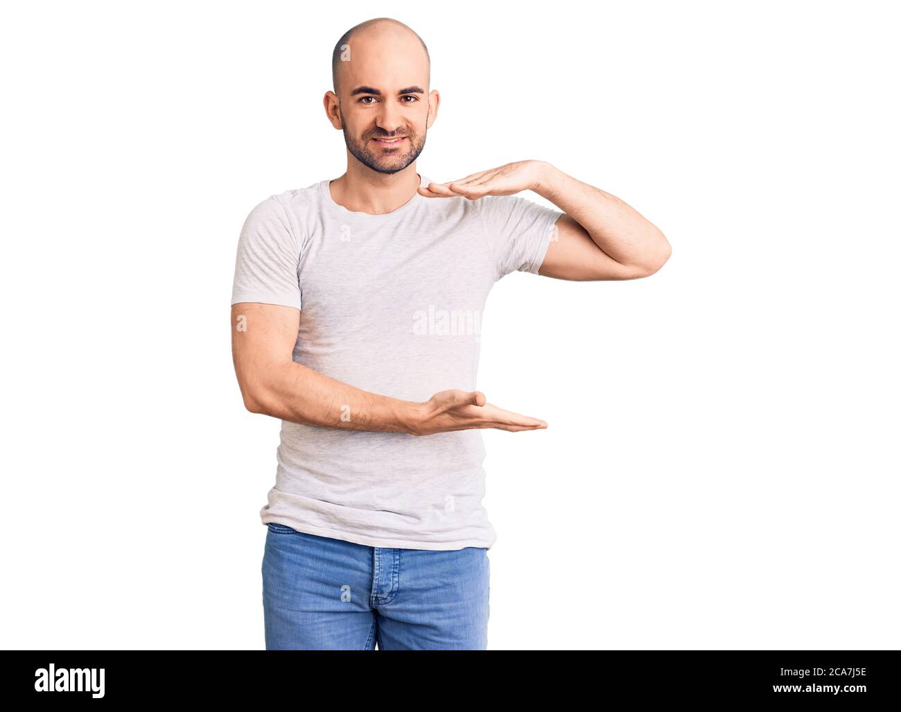 Young handsome man wearing casual t shirt gesturing with hands showing ...
