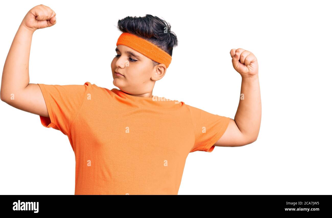 Little boy kid wearing sportswear showing arms muscles smiling proud ...