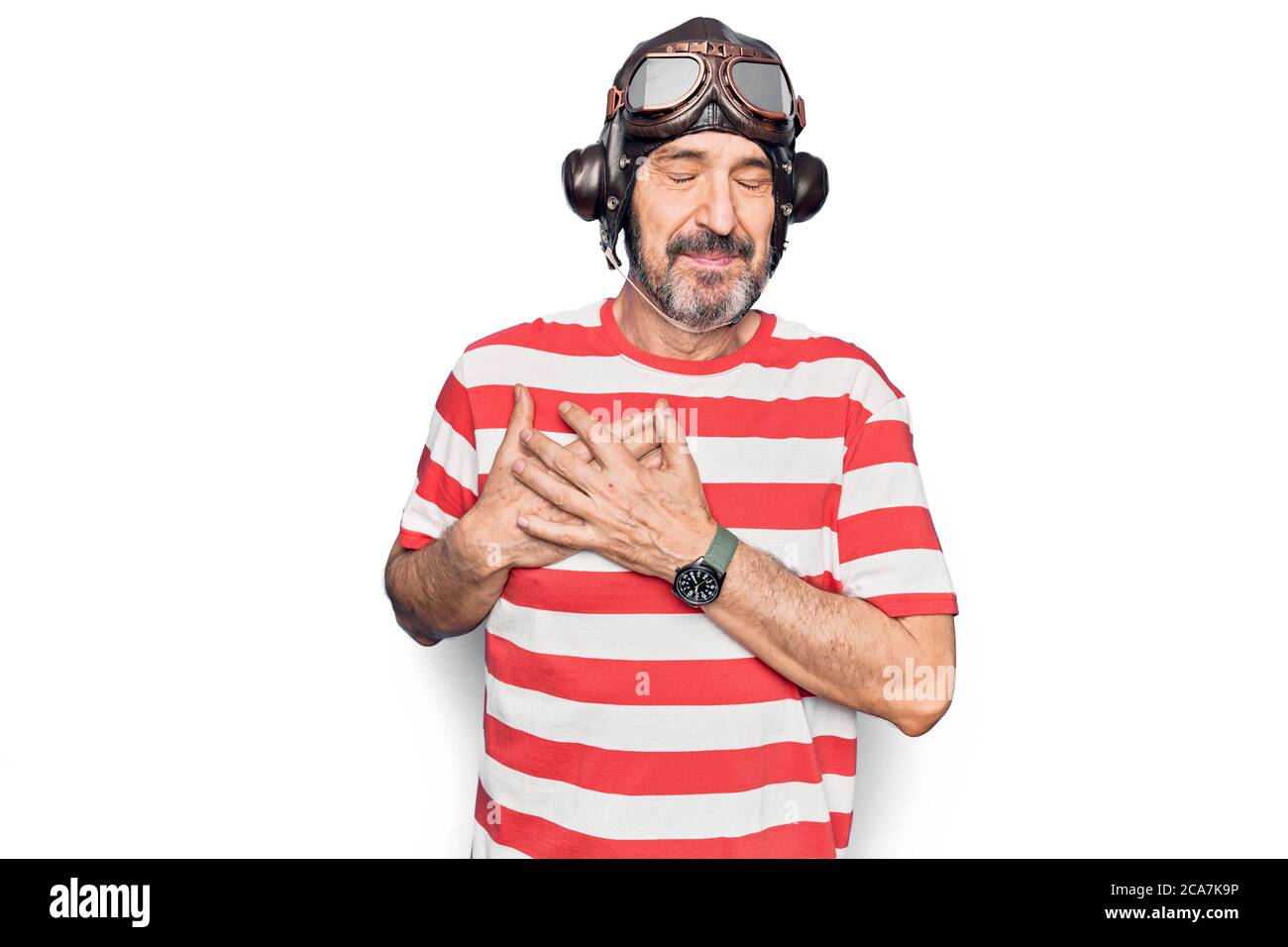 Middle age aviator man wearing vintage helmet and glasses over isolated ...