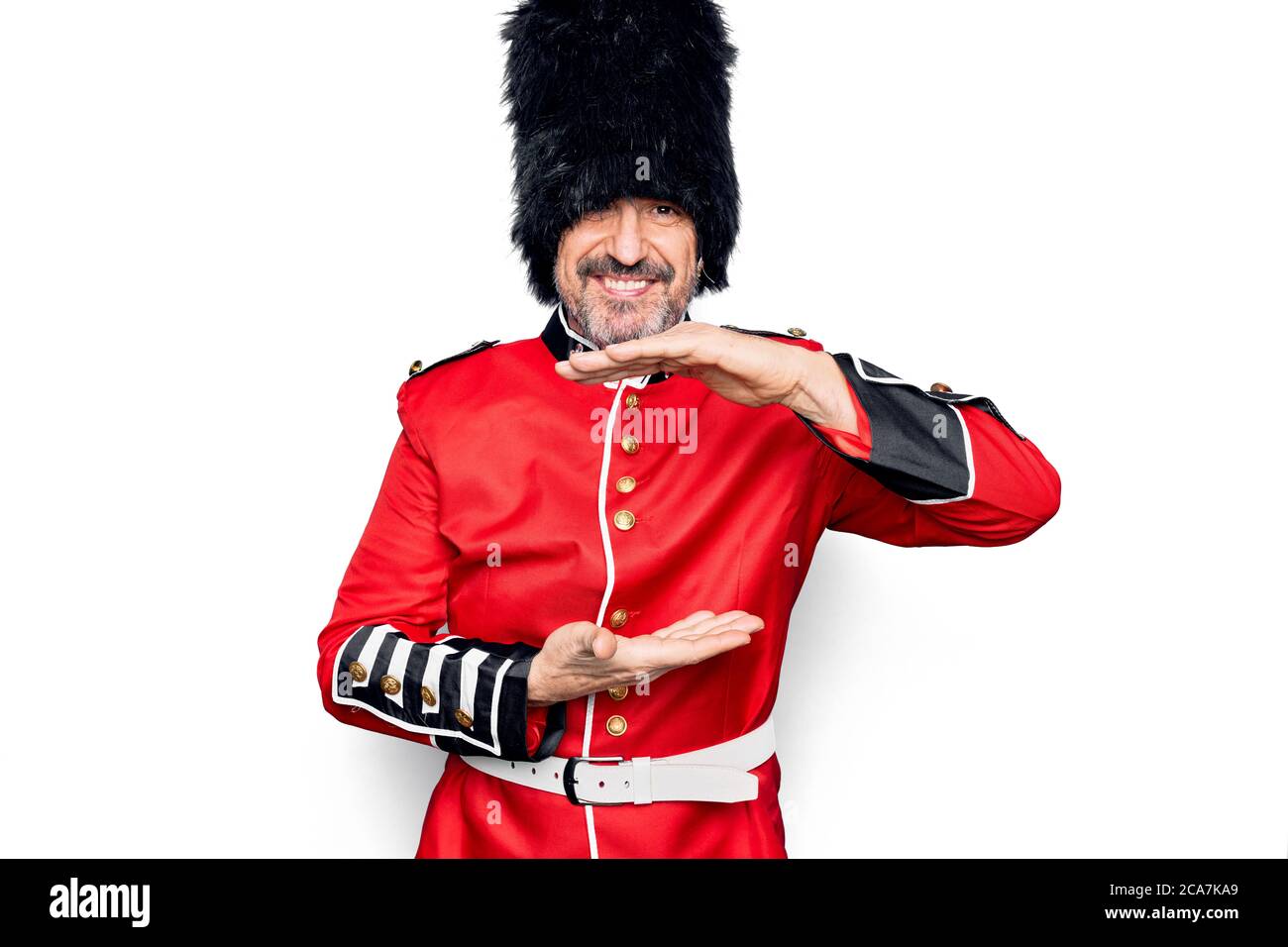 Middle age handsome wales guard man wearing traditional uniform over ...