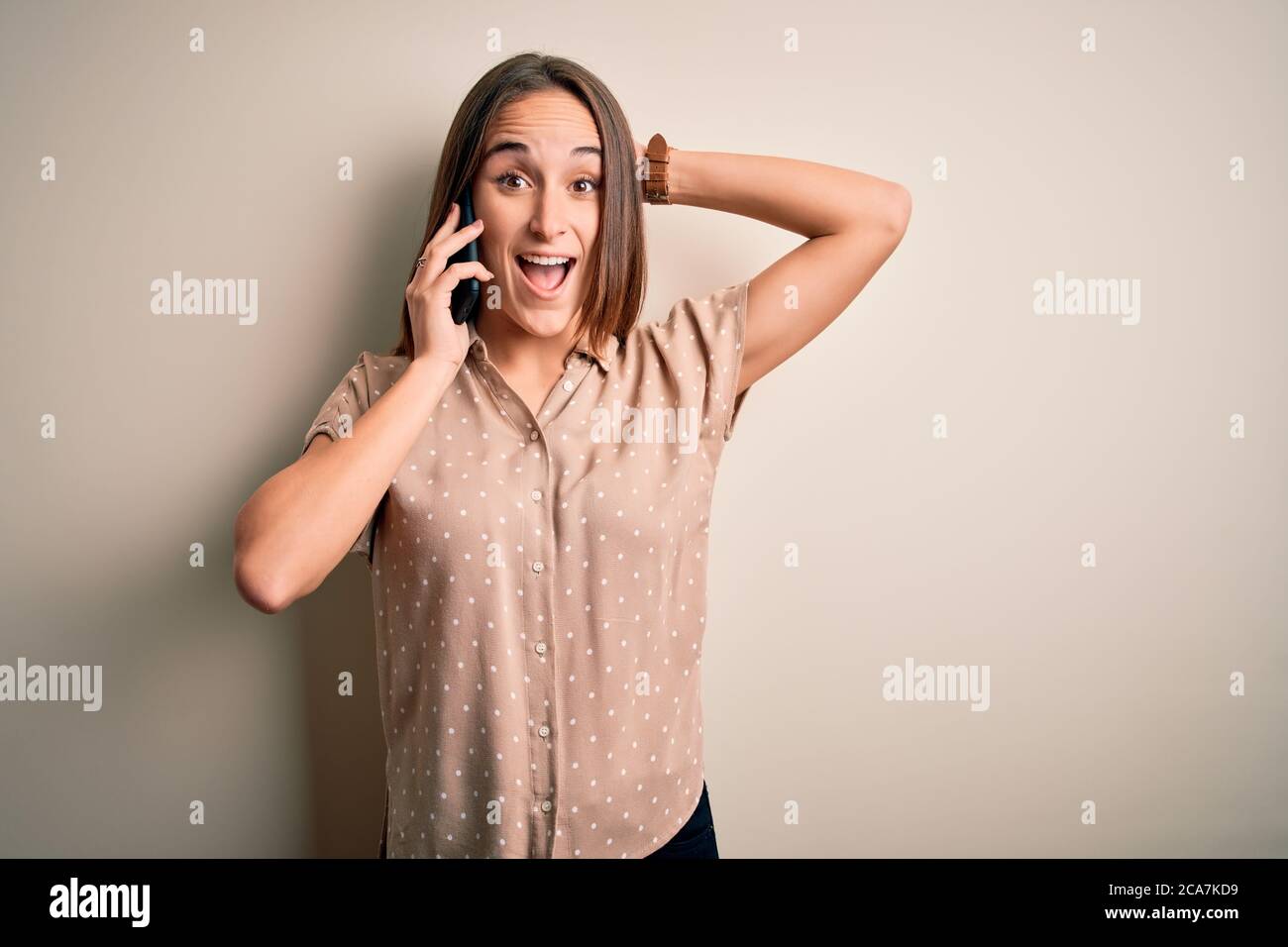 Young beautiful woman having conversation talking on the smartphone ...