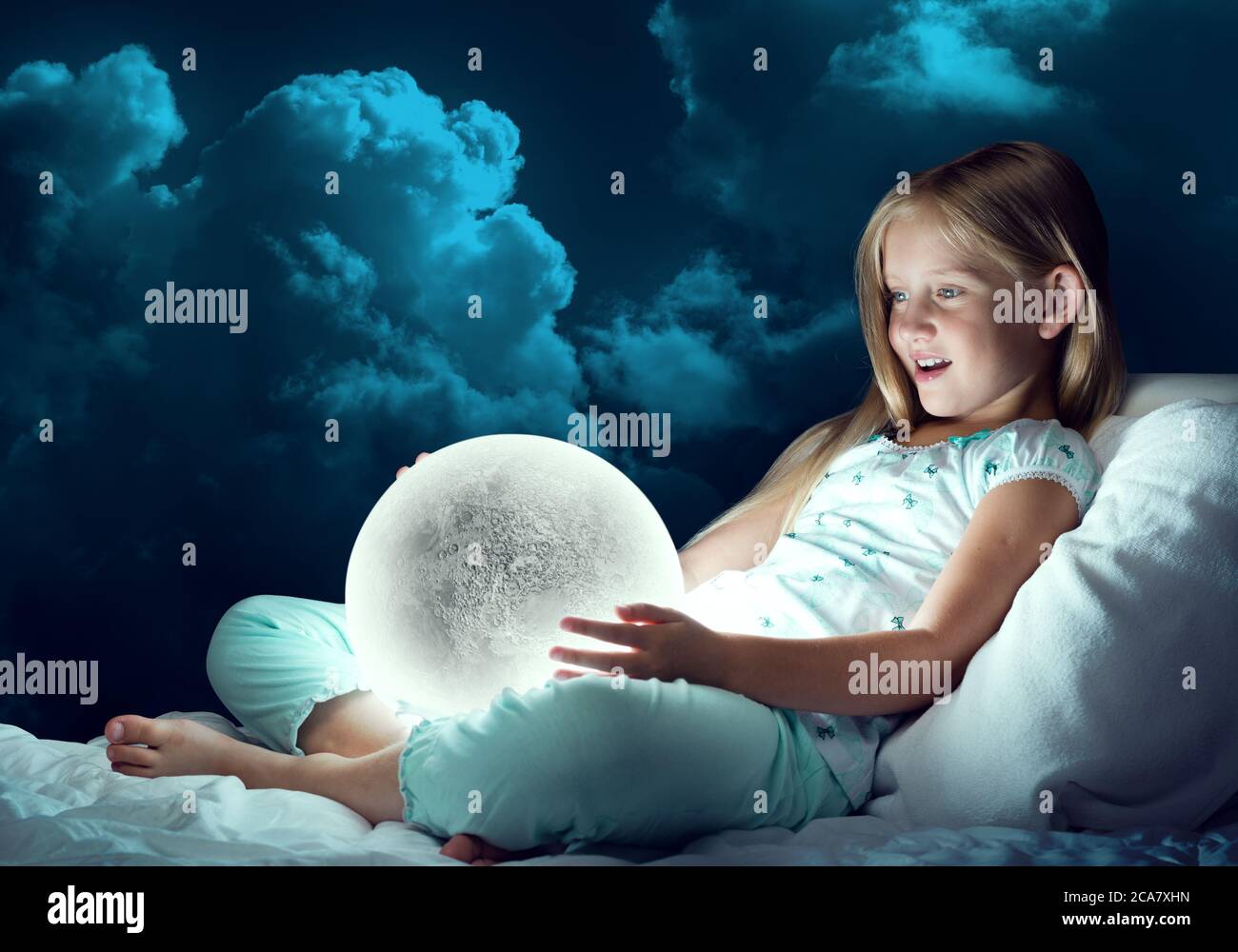 Girl in her bed and moon planet Stock Photo - Alamy