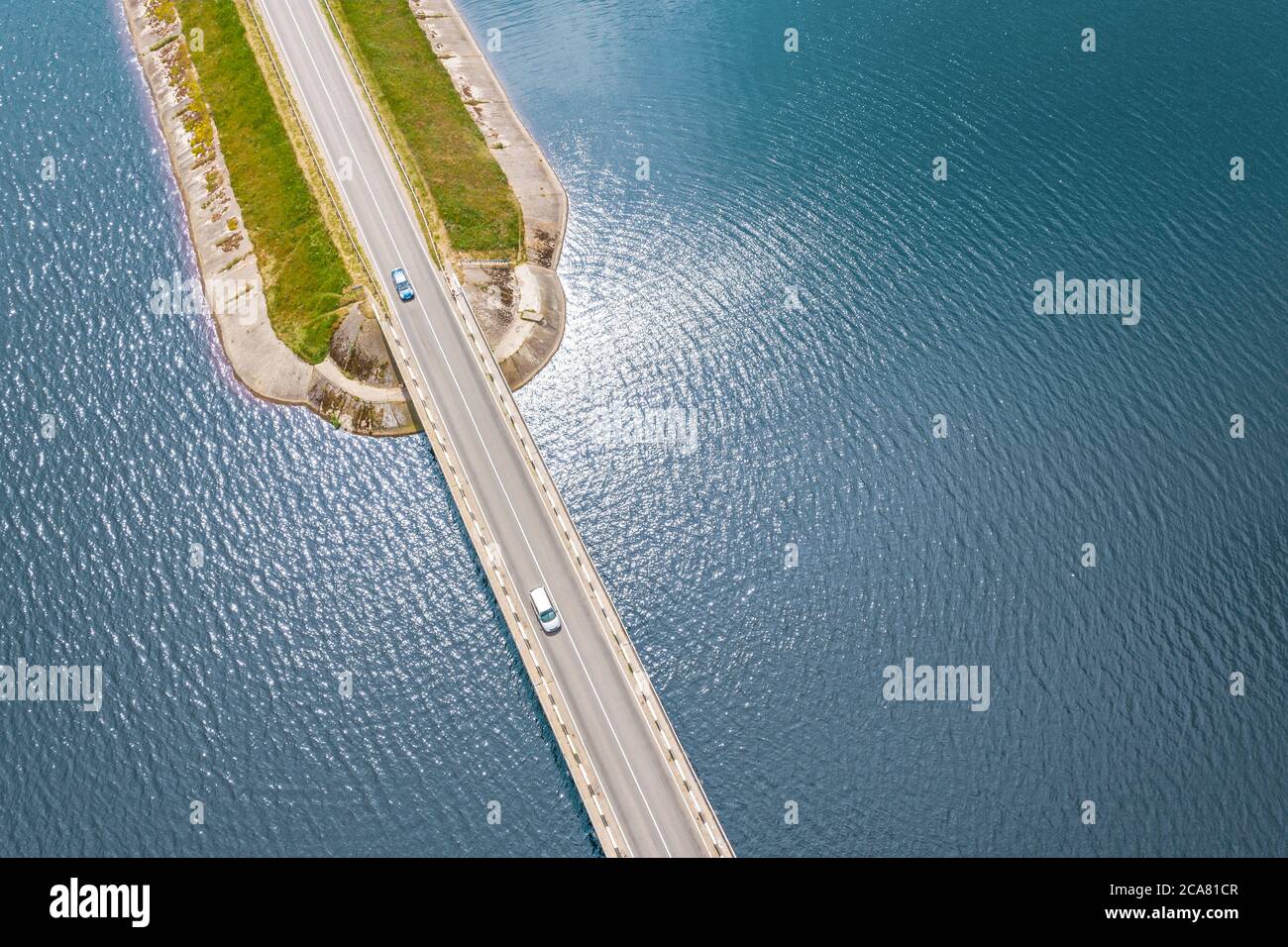 aerial view of bridge and road across blue lake at summertime Stock ...
