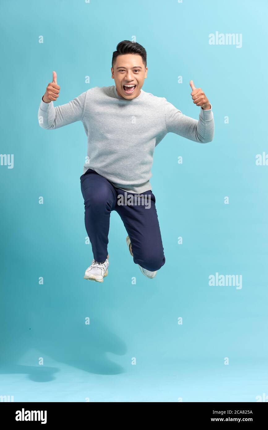 Full length portrait of an excited bearded man jumping and showing ...