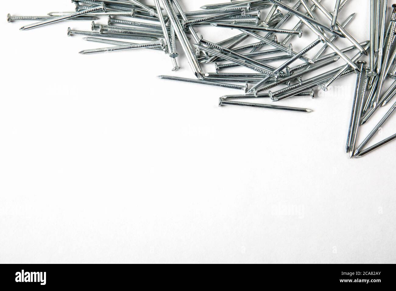 Heap of Metal Steel Nails on white background. Place for Your Text ...