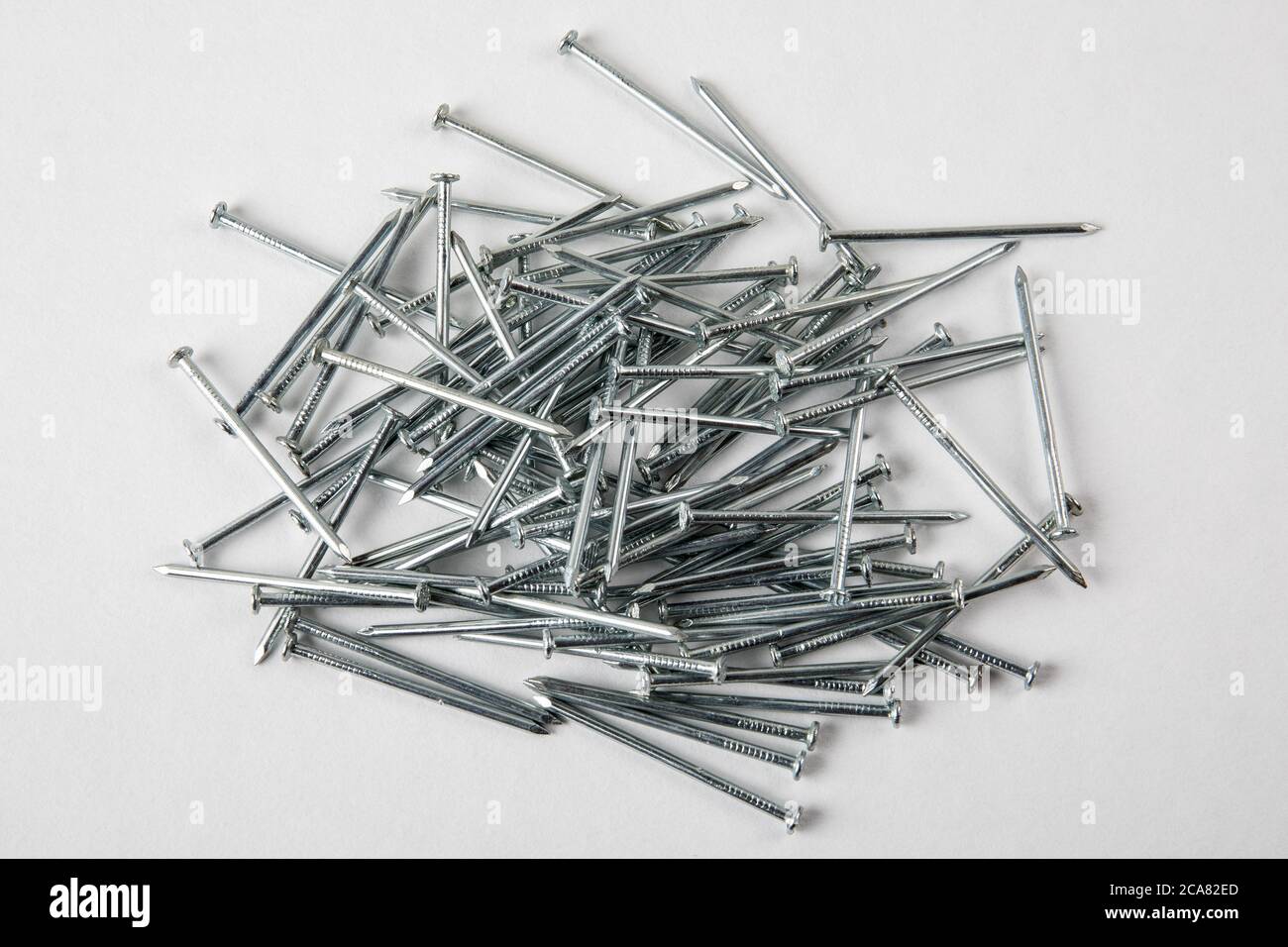 Heap of Metal Steel Nails on white background Stock Photo - Alamy
