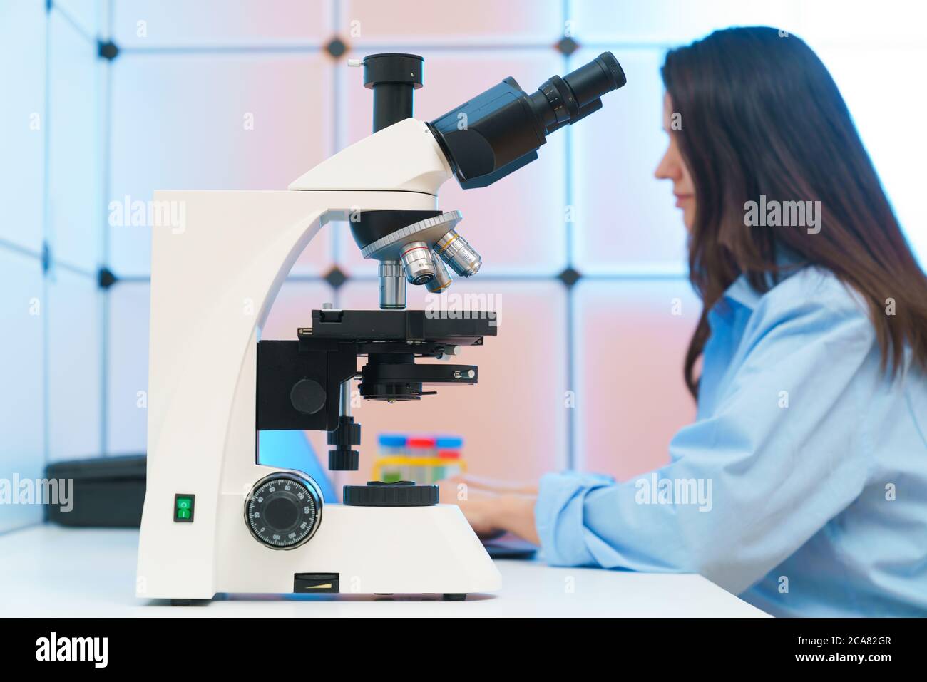 Young woman in a science lab. Health care researchers working in life ...