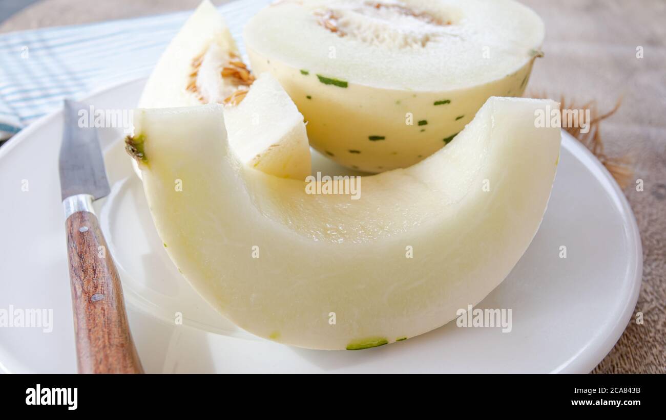 white melon cut in a plate Stock Photo - Alamy