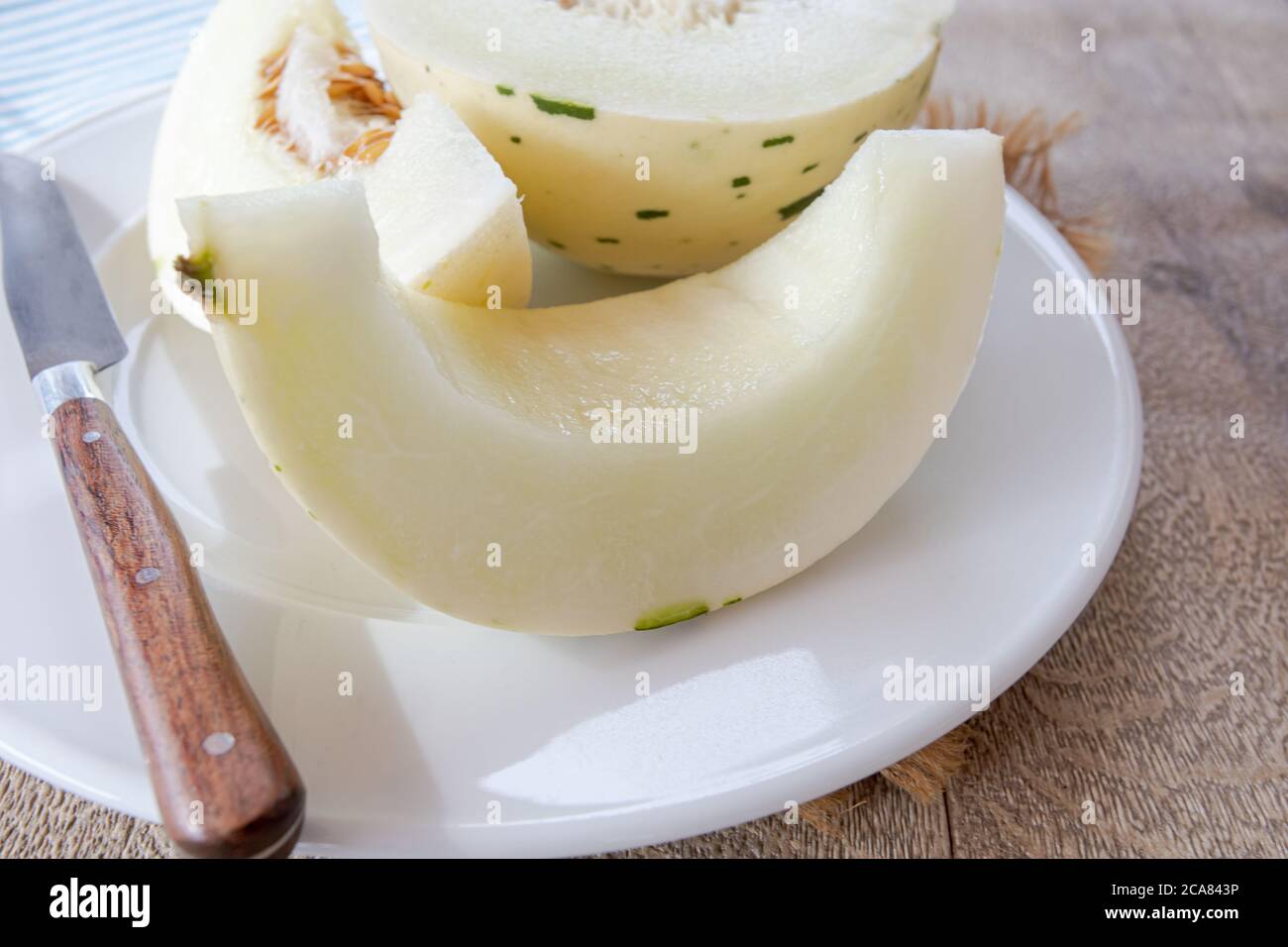 white melon cut in a plate Stock Photo - Alamy
