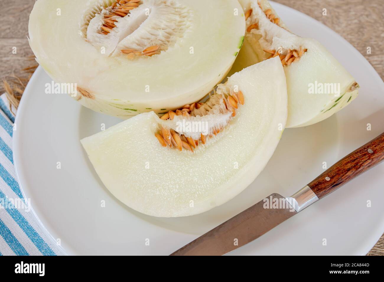white melon cut in a plate Stock Photo - Alamy