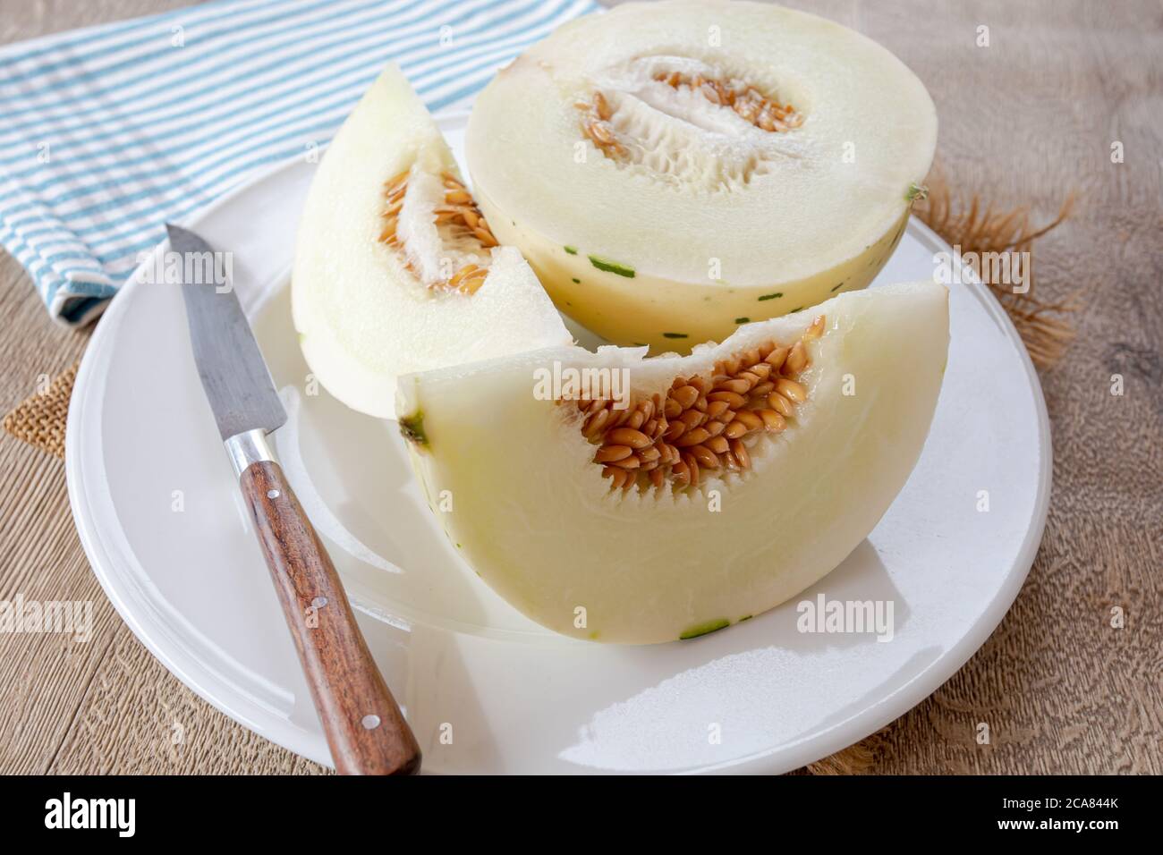 white melon cut in a plate Stock Photo - Alamy