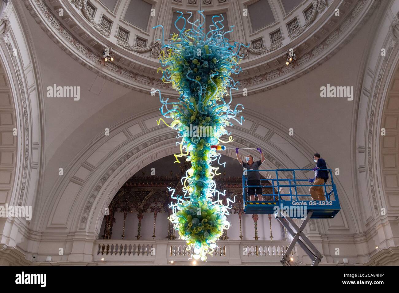 Museum Technician Andy Monk cleans the 27 foot glass Rotunda Chandelier ...