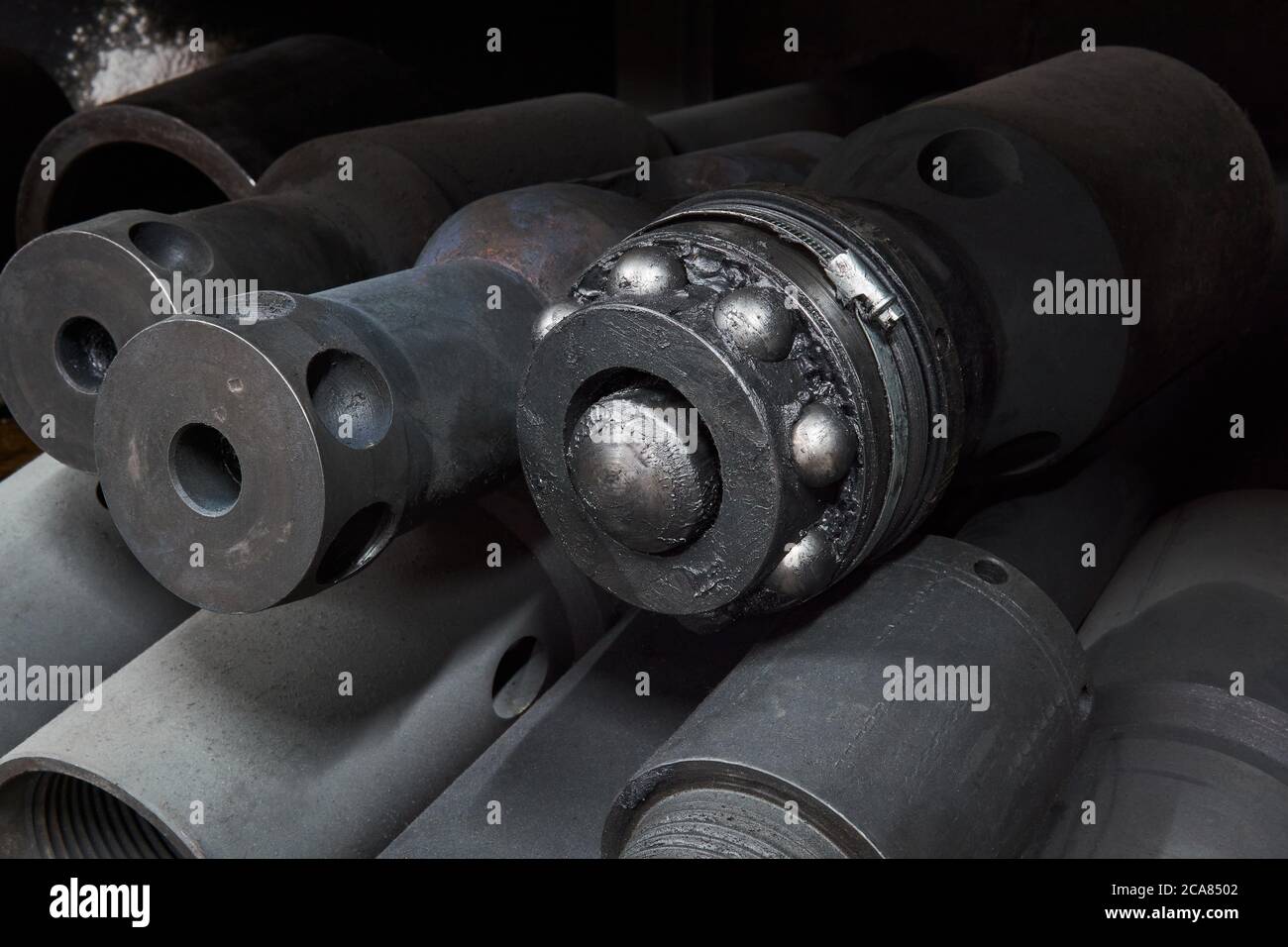 oiled metal parts of drilling rigs are in the warehouse, close-up Stock ...