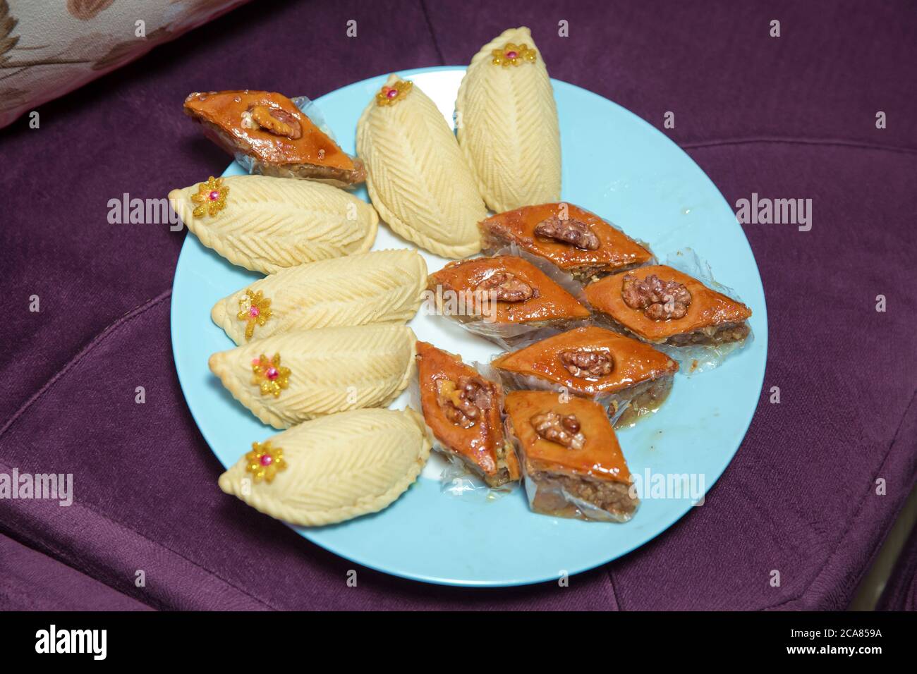 Shekerbura with nuts and honey. Baklava and Shekerbura blue plate ...