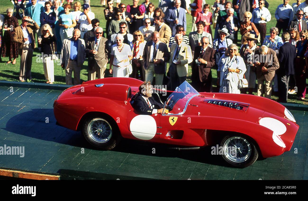 Phil Hill driving a Ferrari Testa Rossa sports racing car off the ramp ...