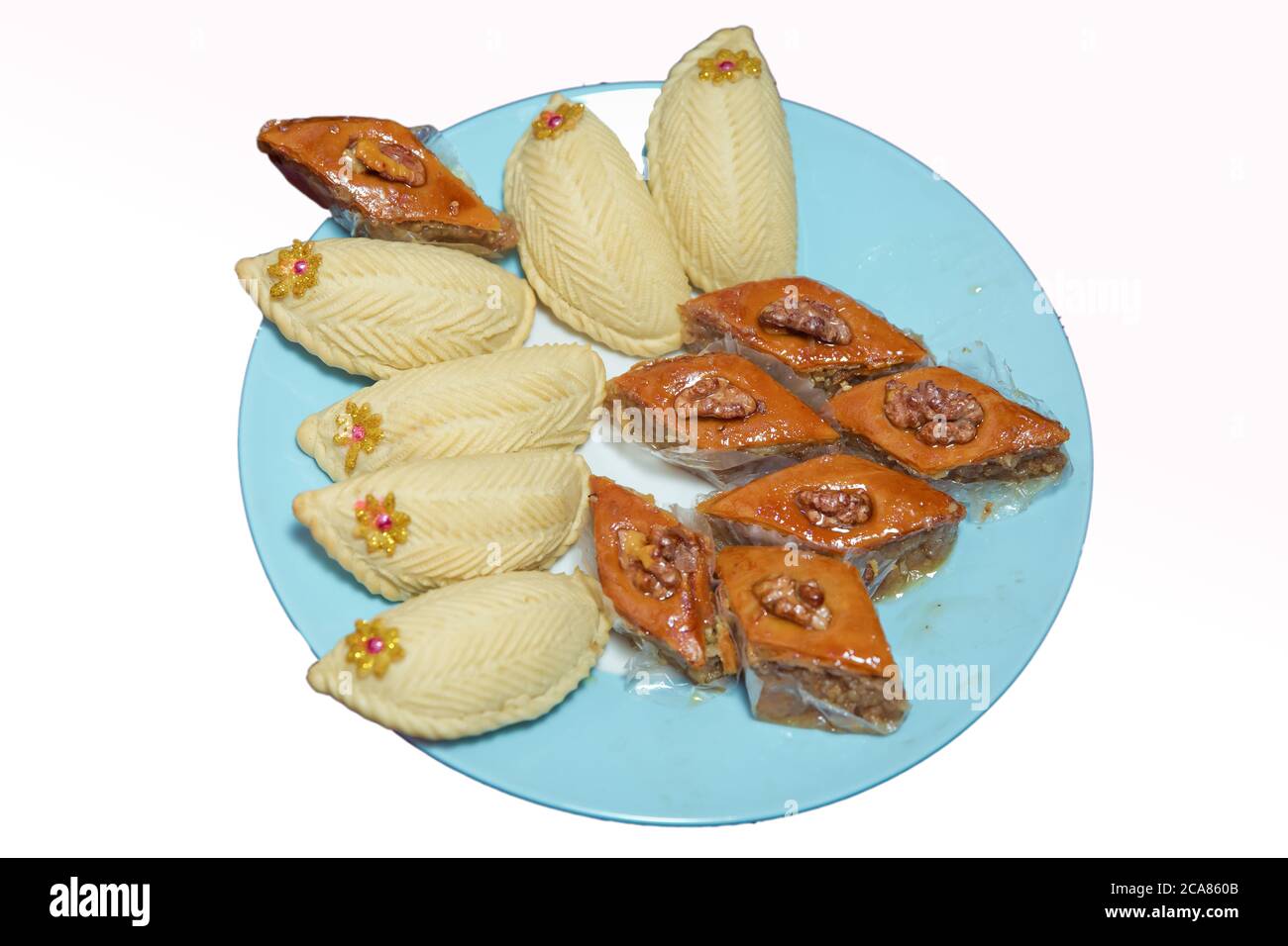 Shekerbura with nuts and honey. Baklava and Shekerbura blue plate ...