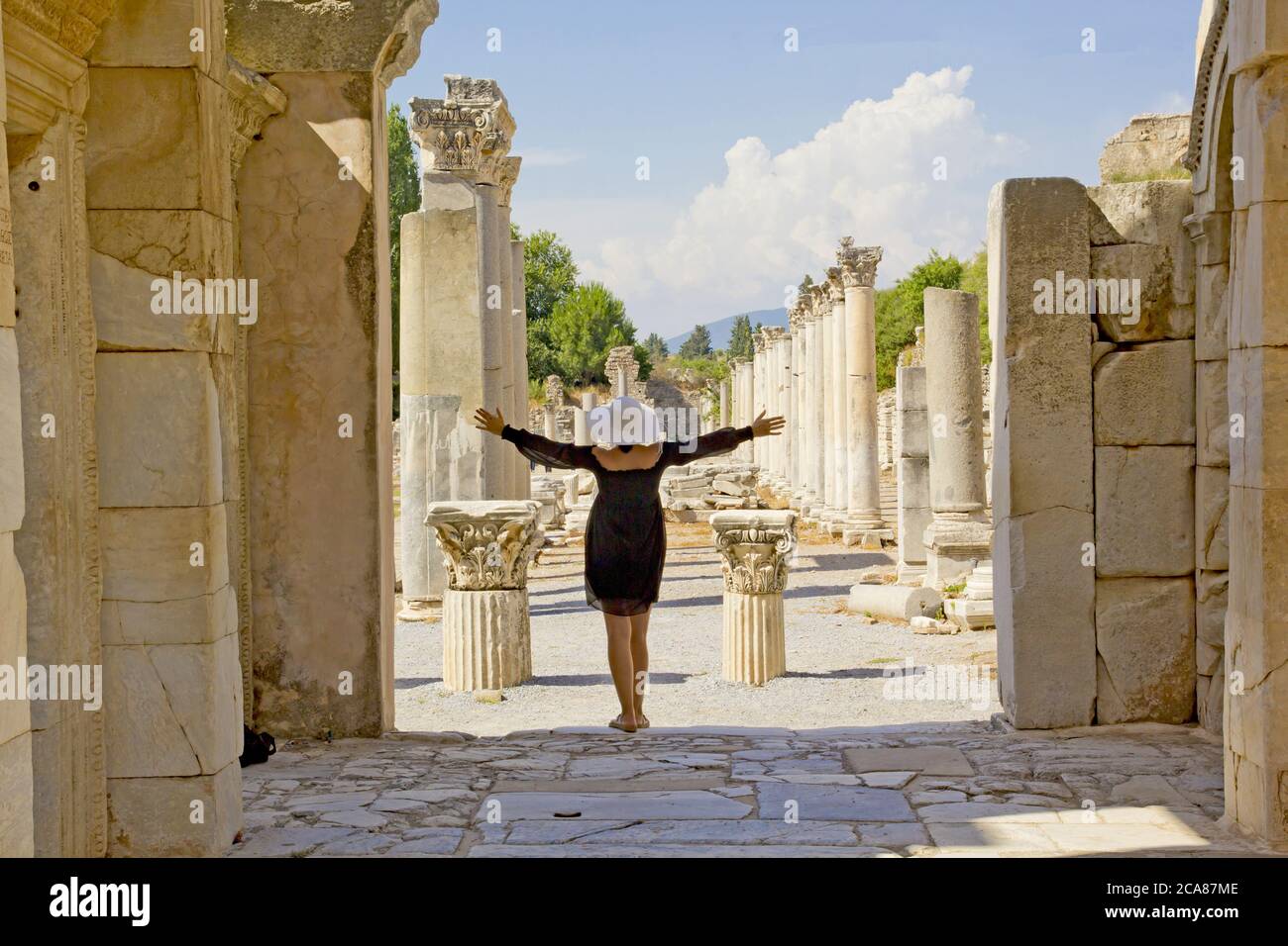 Beautiful young woman in black dress in Ephesus ancient city Stock ...