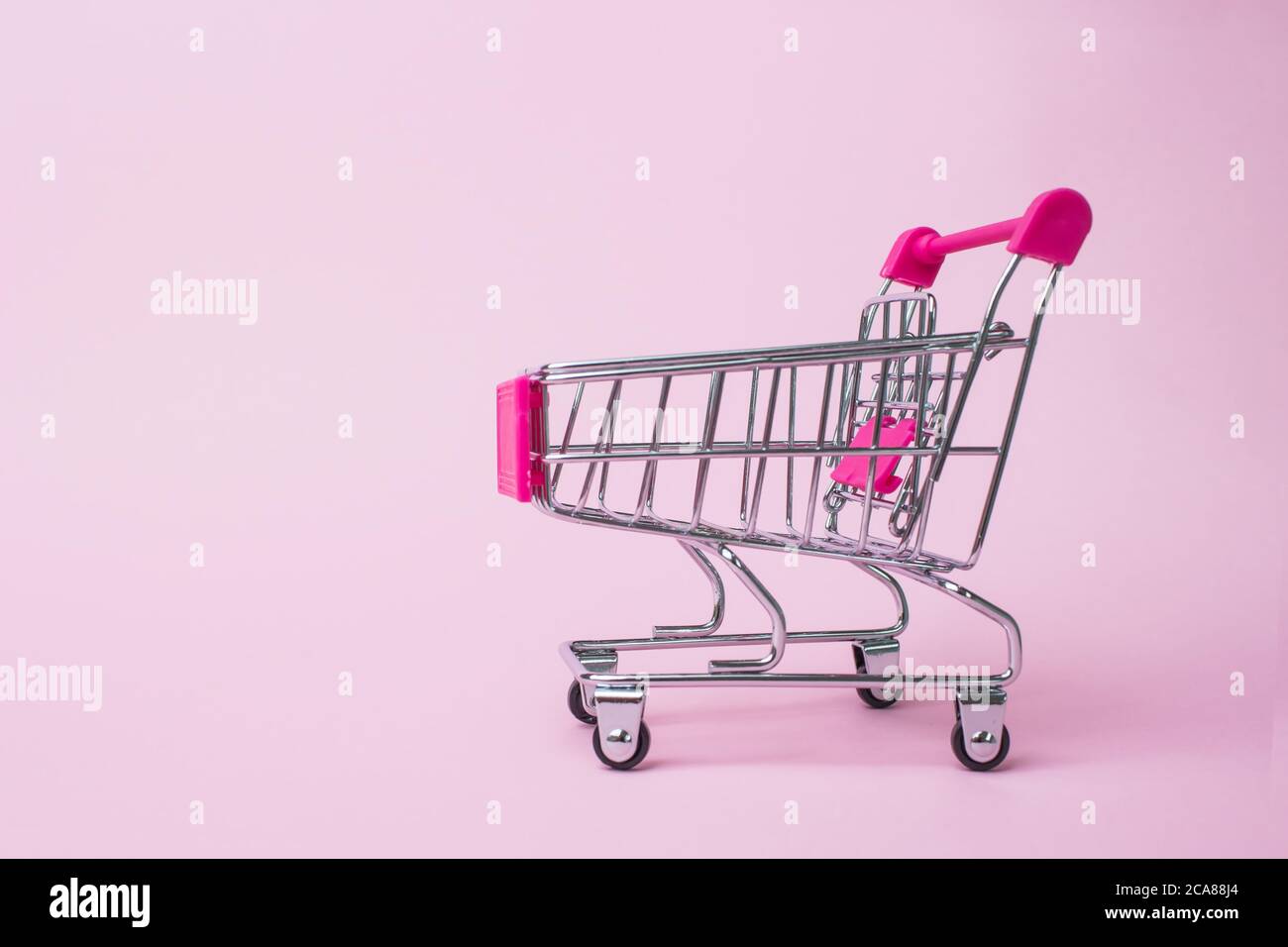 Annual sale shopping season concept - mini pink shop cart trolley on ...