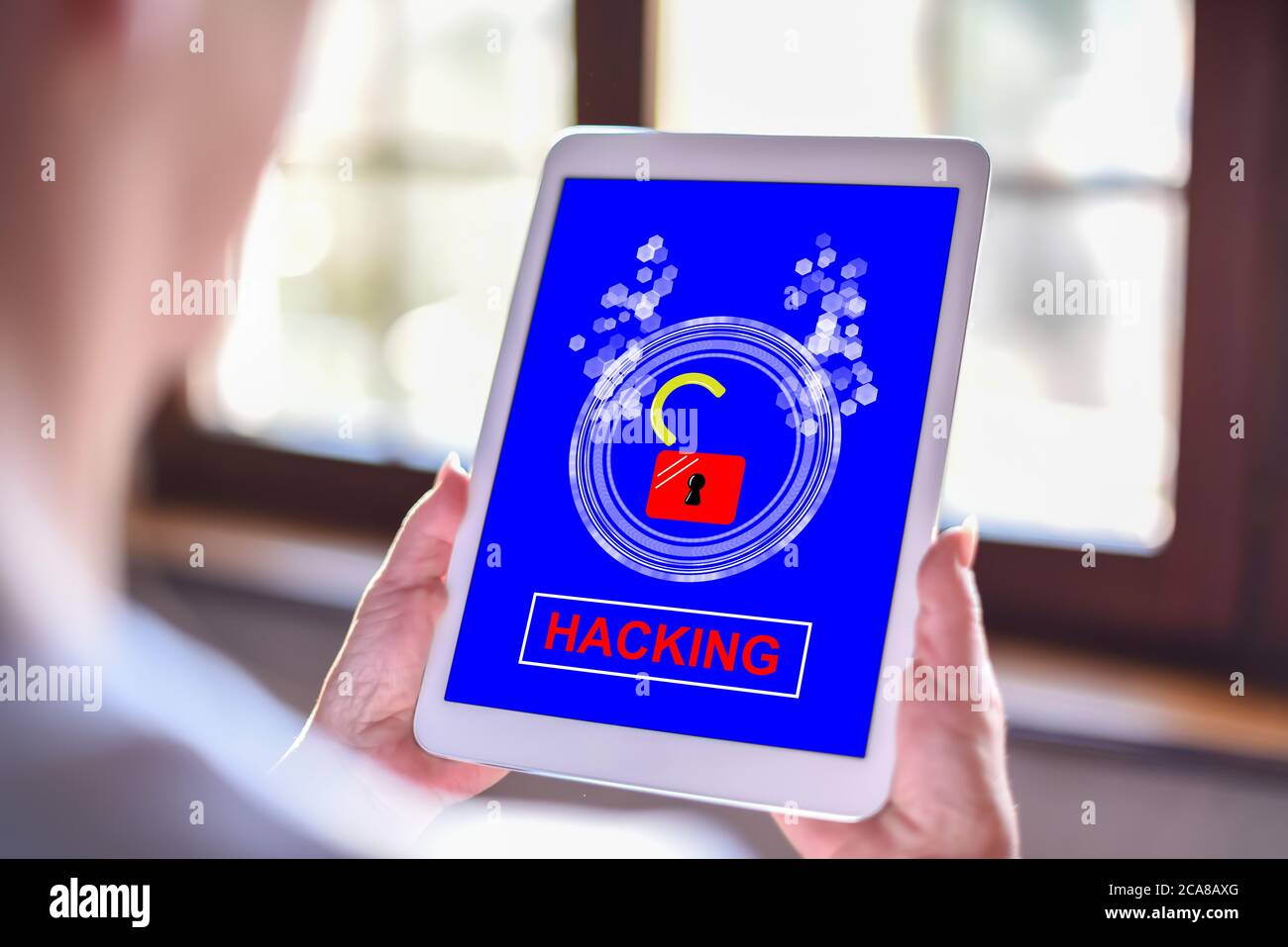 Tablet screen displaying a hacking concept Stock Photo - Alamy