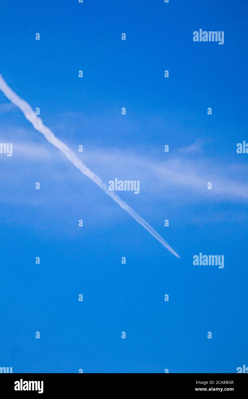 elongated white clouds formed by jet fumes Stock Photo - Alamy