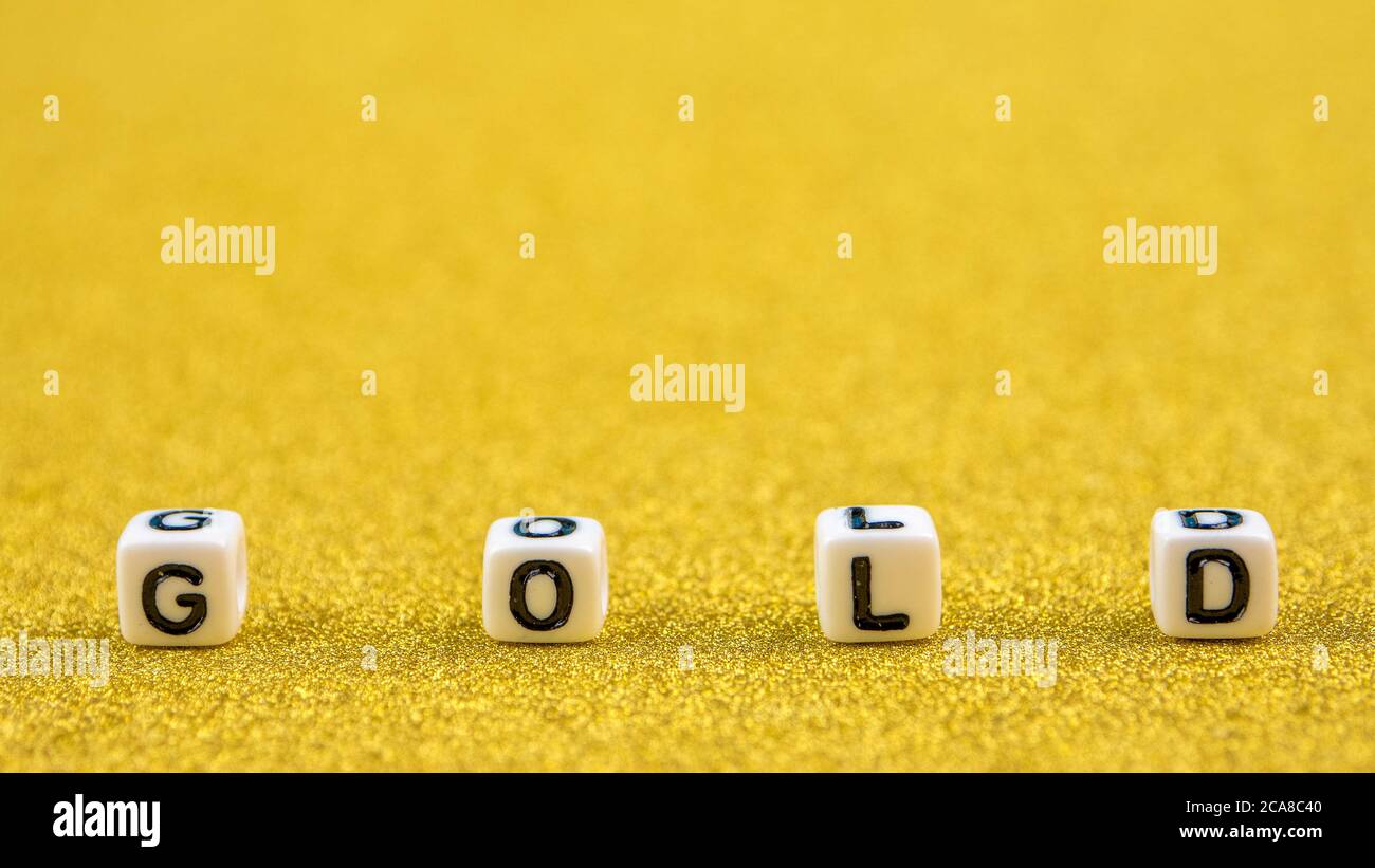 gold word formed by white dices with black letters laying in bottom ...