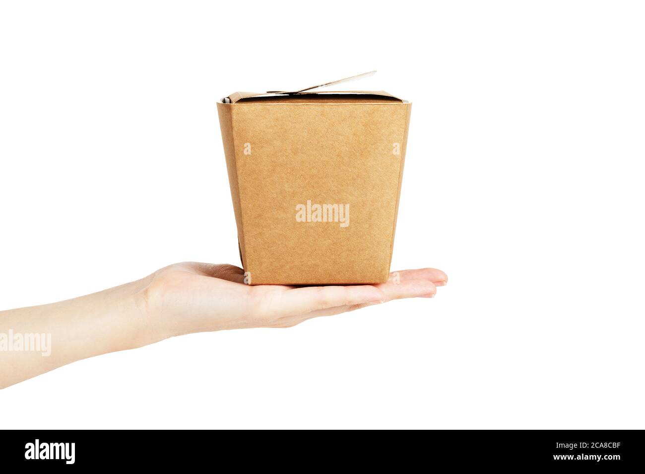 Craft square box for food delivery in a female hand on a white ...