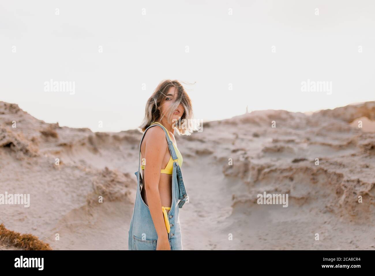 Woman in the beach wearing yellow swimsuit Stock Photo - Alamy