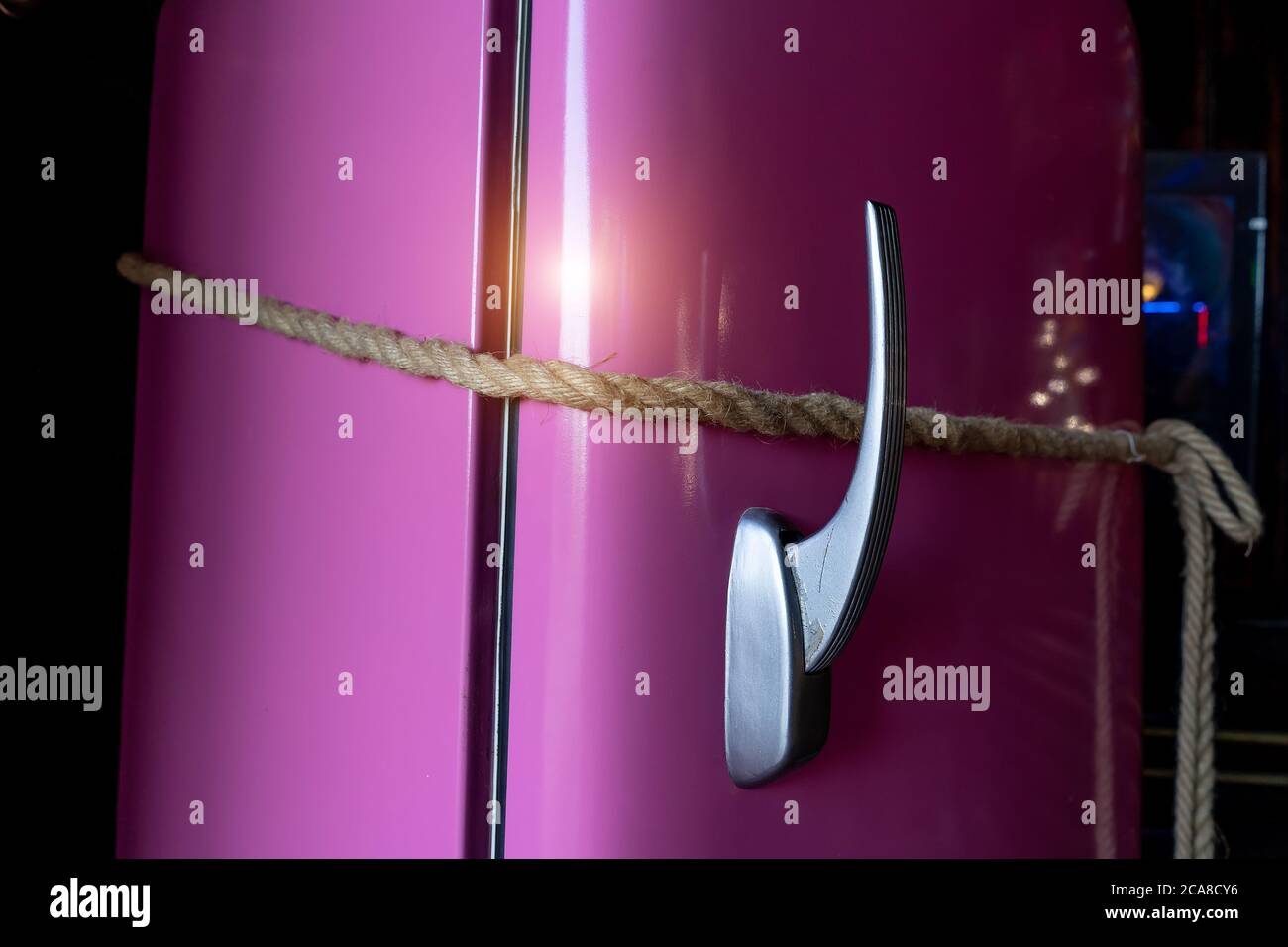 Tied with a rope door pink refrigerator Stock Photo - Alamy