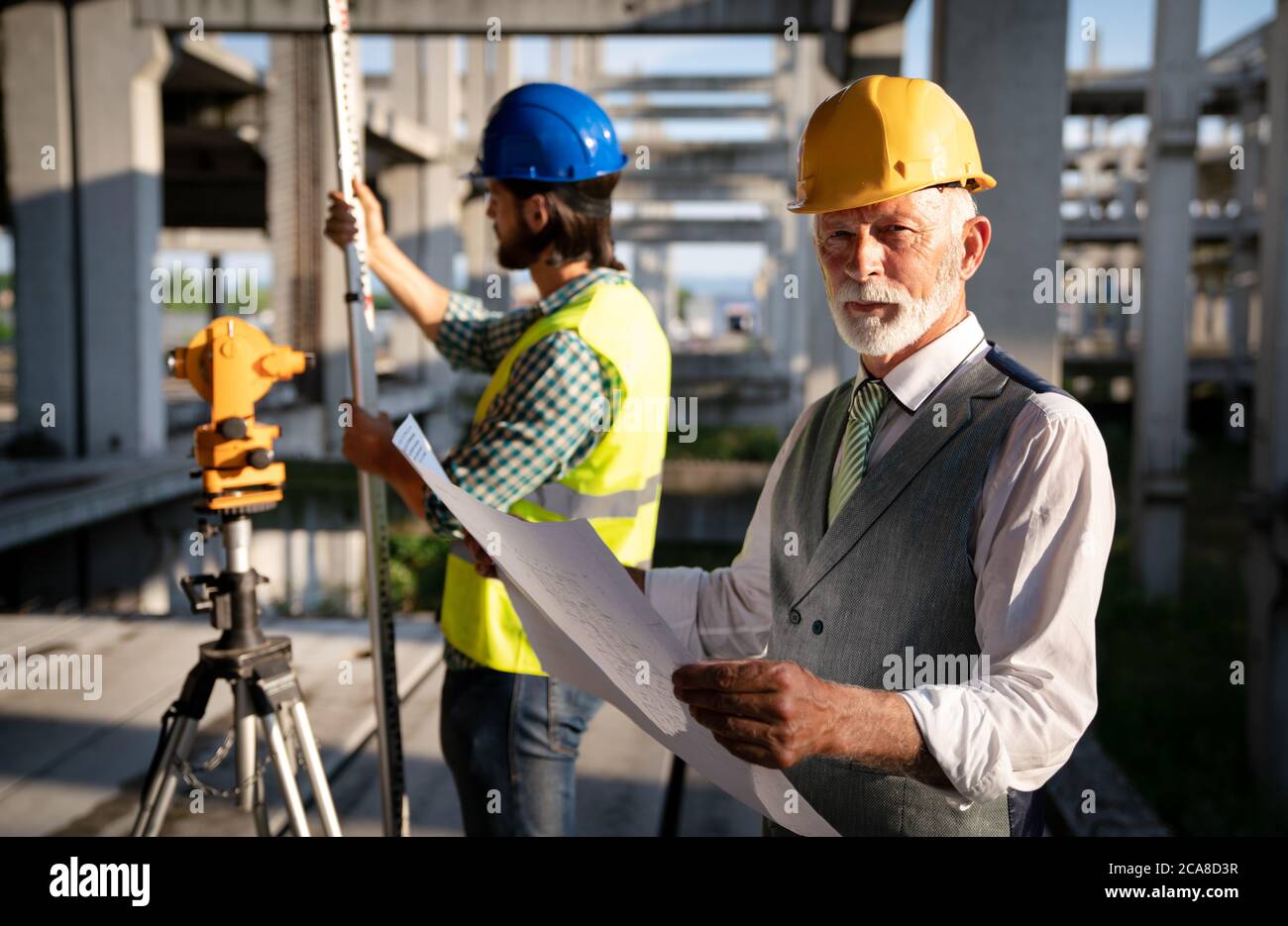 Team of construction engineers, architects working on building site ...