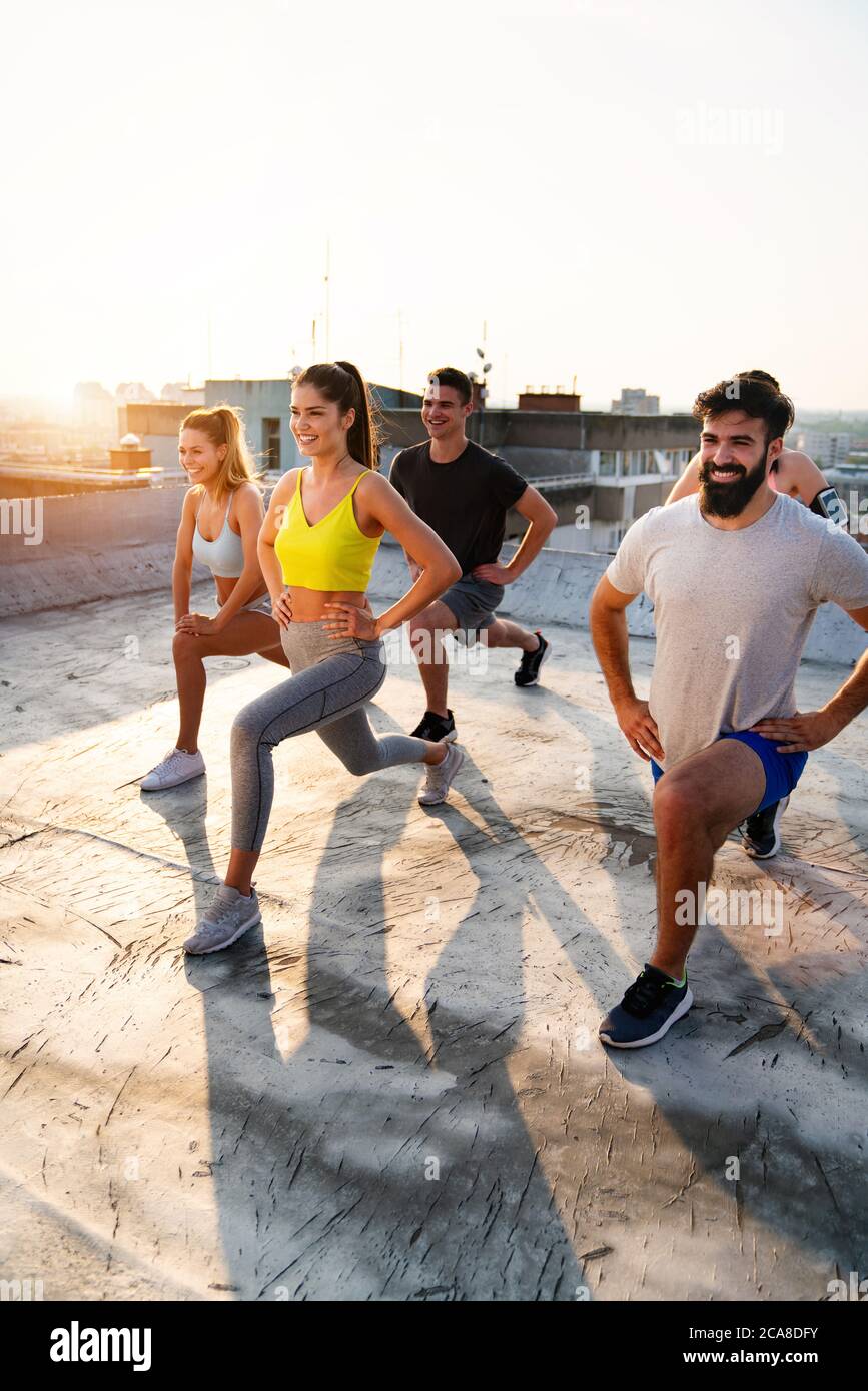 Group of fit healthy friends, people exercising together outdoor Stock ...