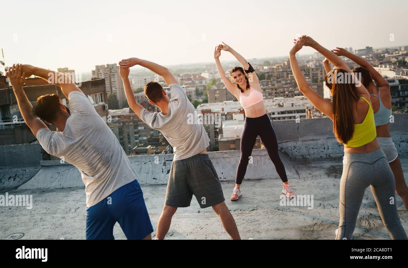 Group of fit healthy friends, people exercising together outdoor Stock ...
