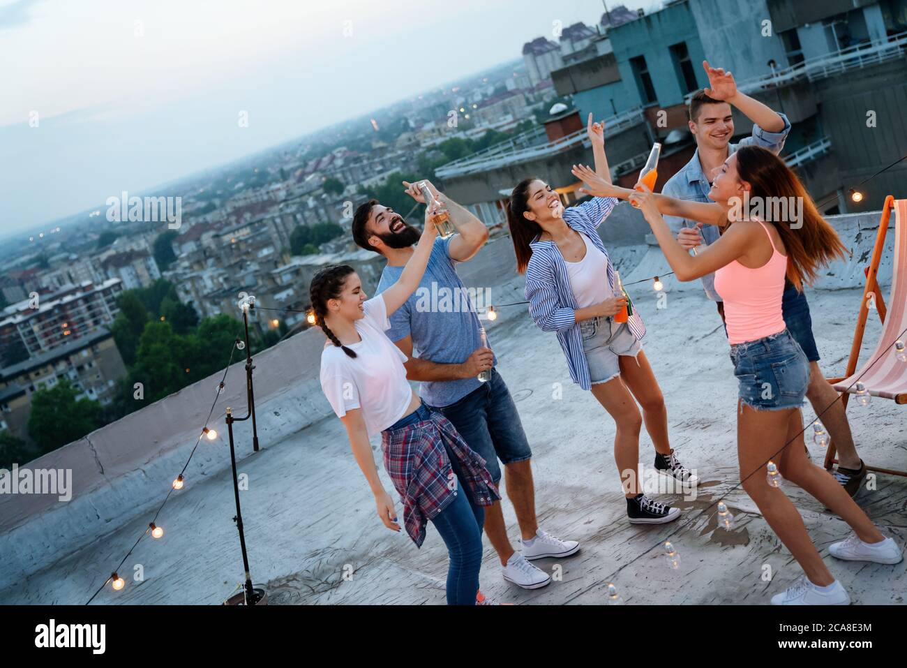 Group of happy young people friends dancing and having fun in party ...