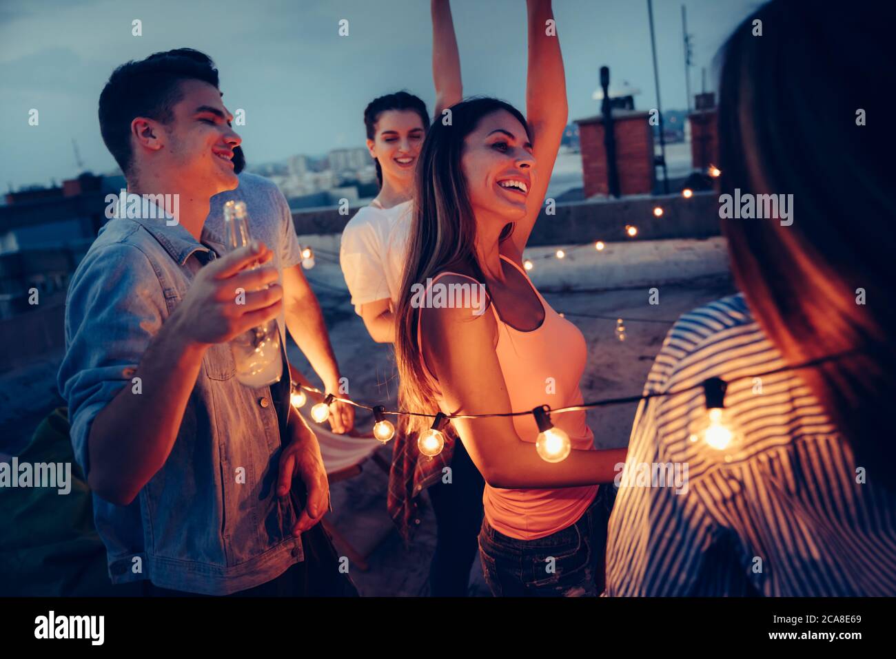Friends enjoying cocktails at a party. Group of happy people having fun ...