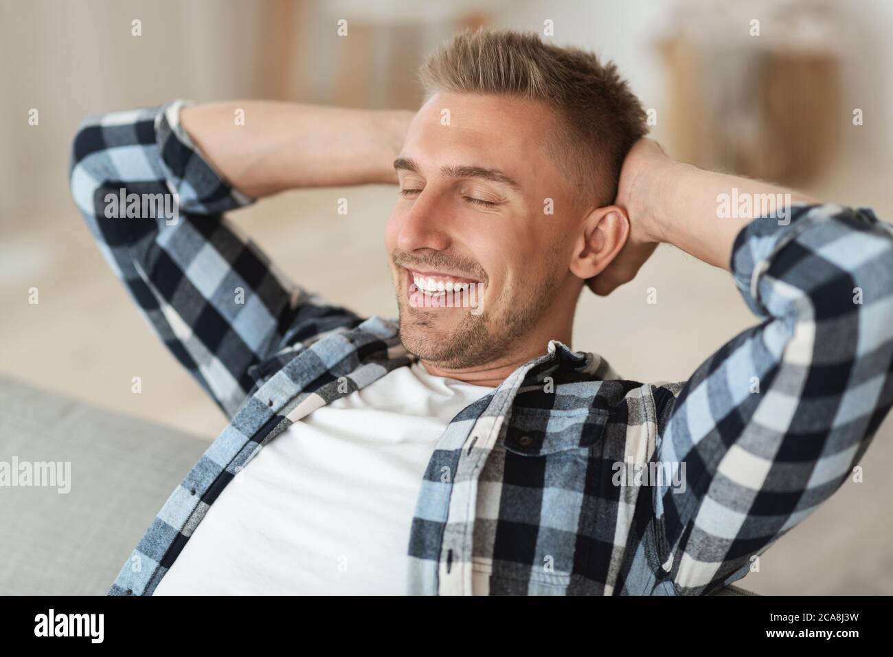Guy having rest at home on the sofa Stock Photo - Alamy