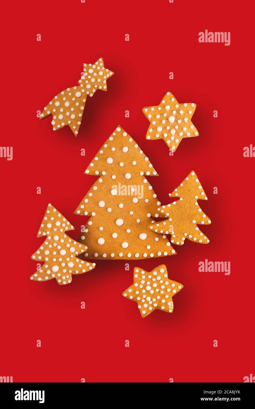 Gingerbread Christmas tree with other cookies balance on red Stock ...