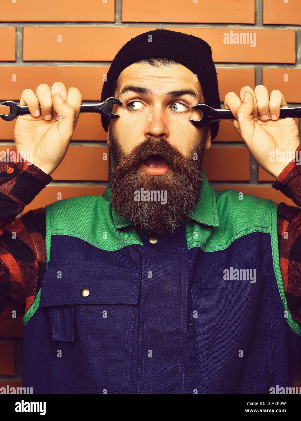 Bearded man, long beard. Brutal caucasian surprised mechanic, unshaven ...