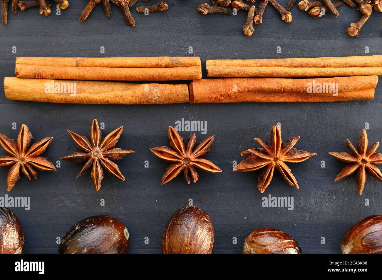 Christmas spices on wooden background. Food ingredients: star anise ...