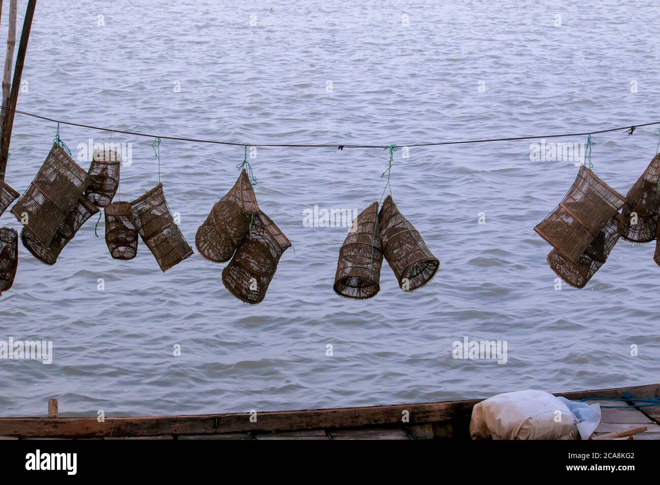 Bamboo fish-trap with a narrow neck - Bangladeshi traditional fishery ...
